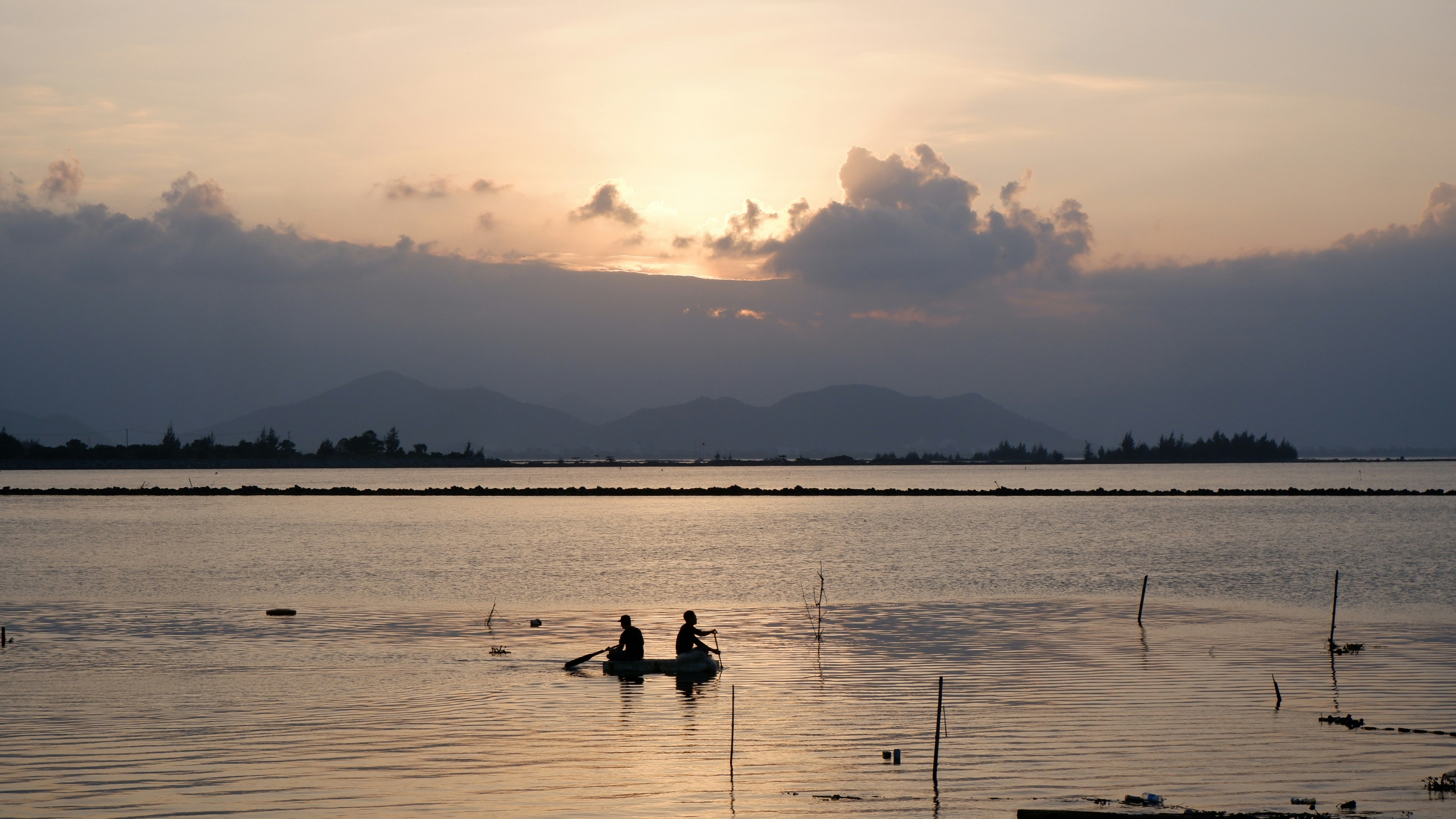Dusk Over the Gentle Bay: Silhouettes in Quiet Water