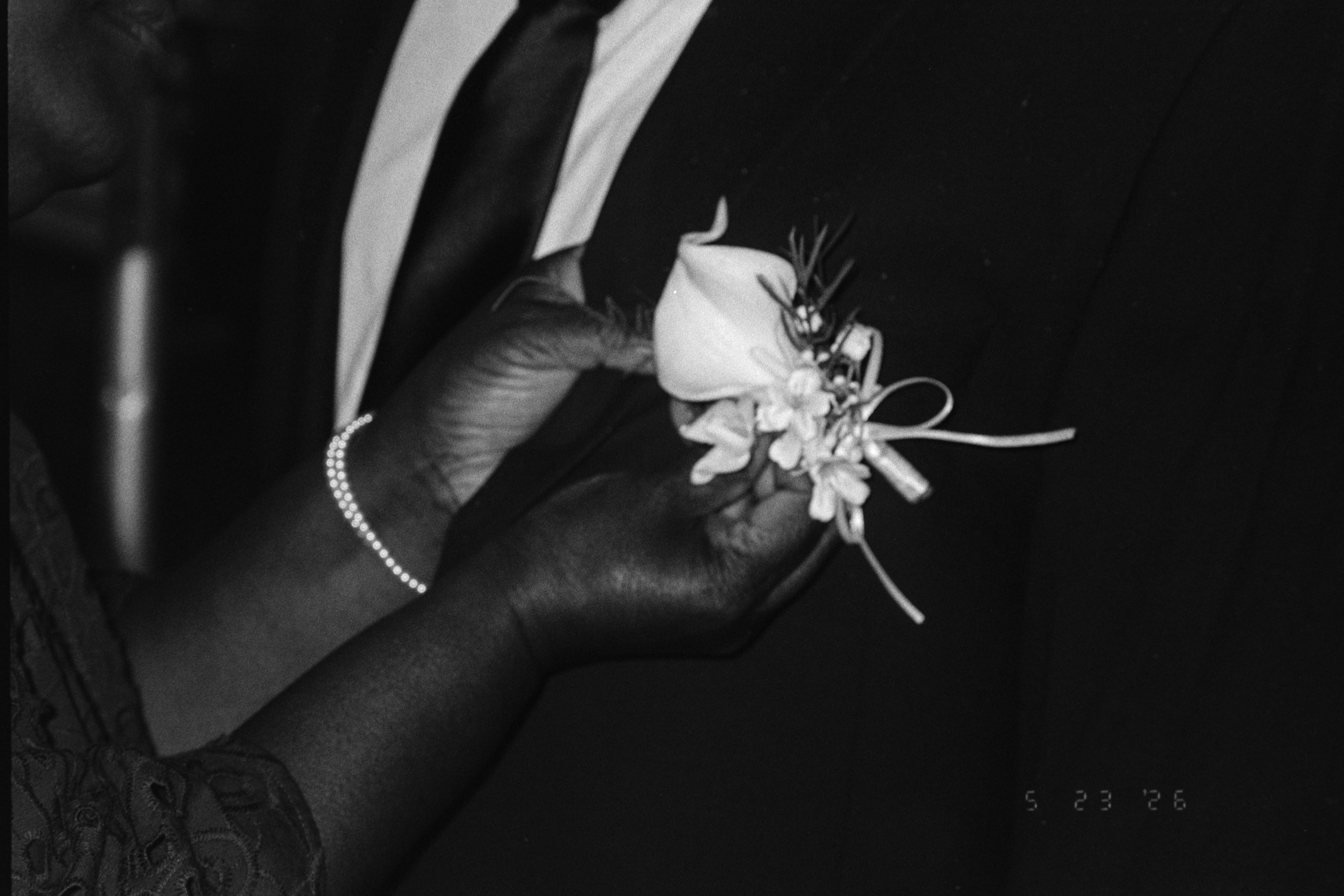 A Silent Bond: The Gentle Hands Adjust a Boutonniere