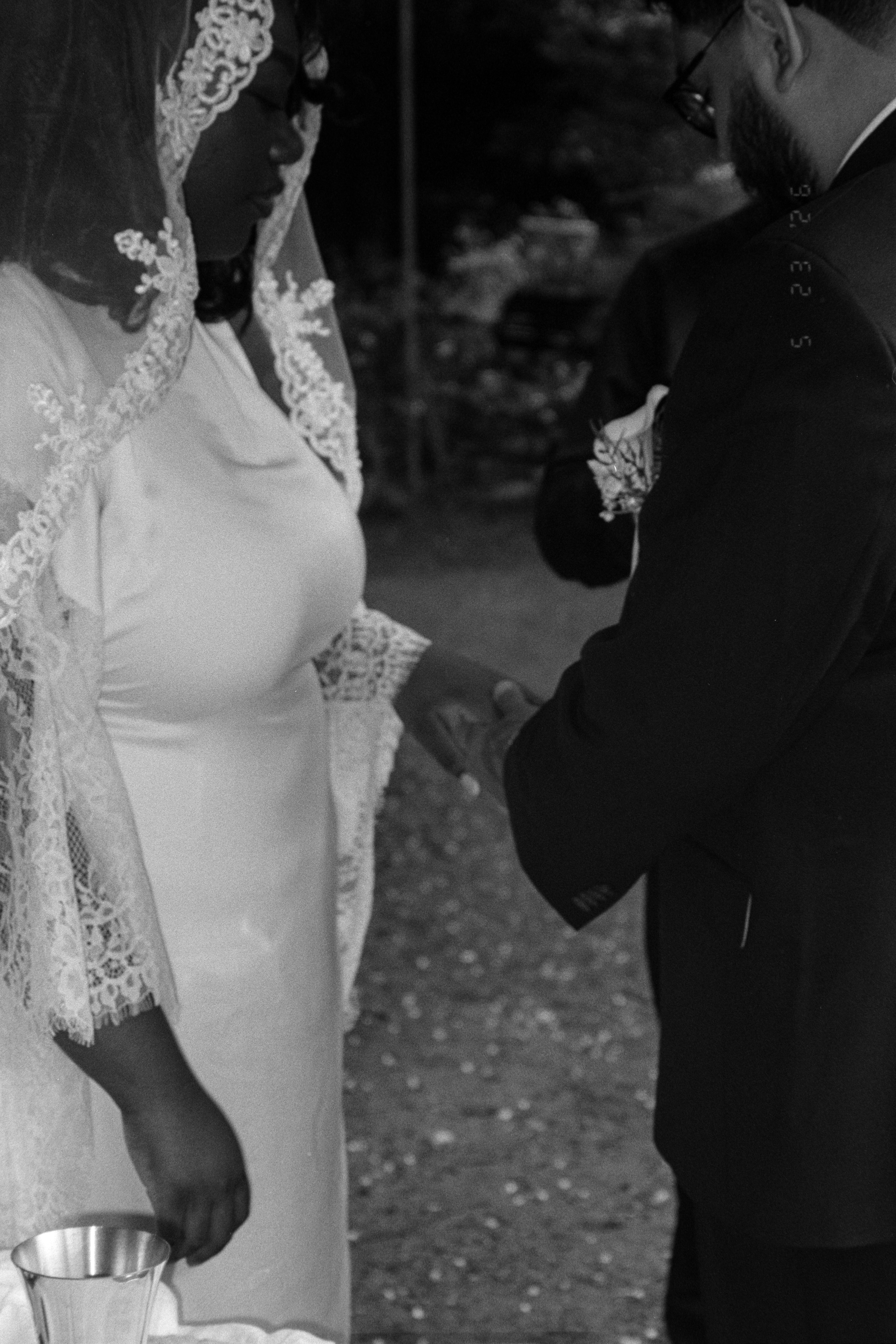 Veil and Vows: Hands Meet Amidst a Quiet Moment