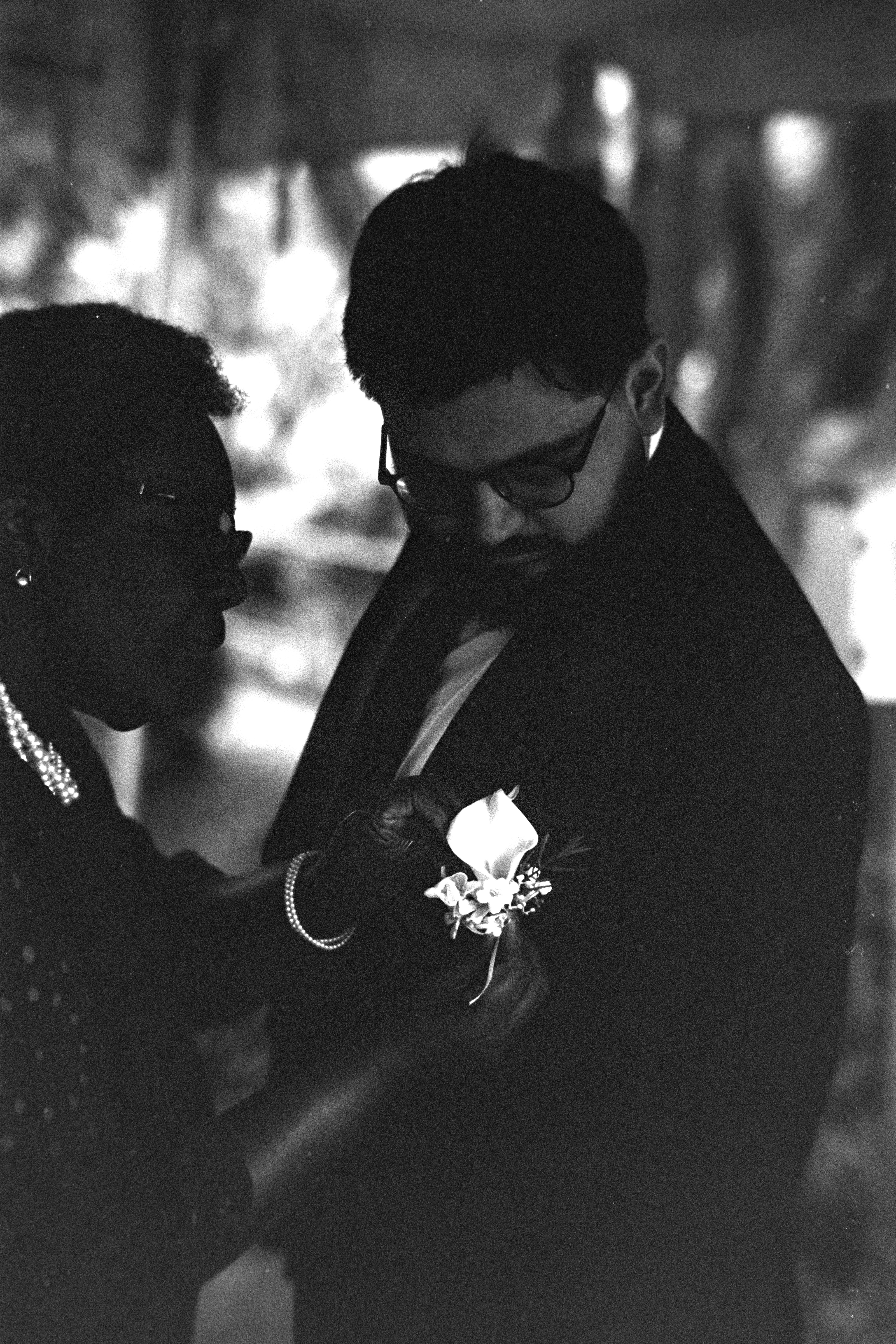 Boutonniere Moment: A Quiet Groom and Corsage in Low Light