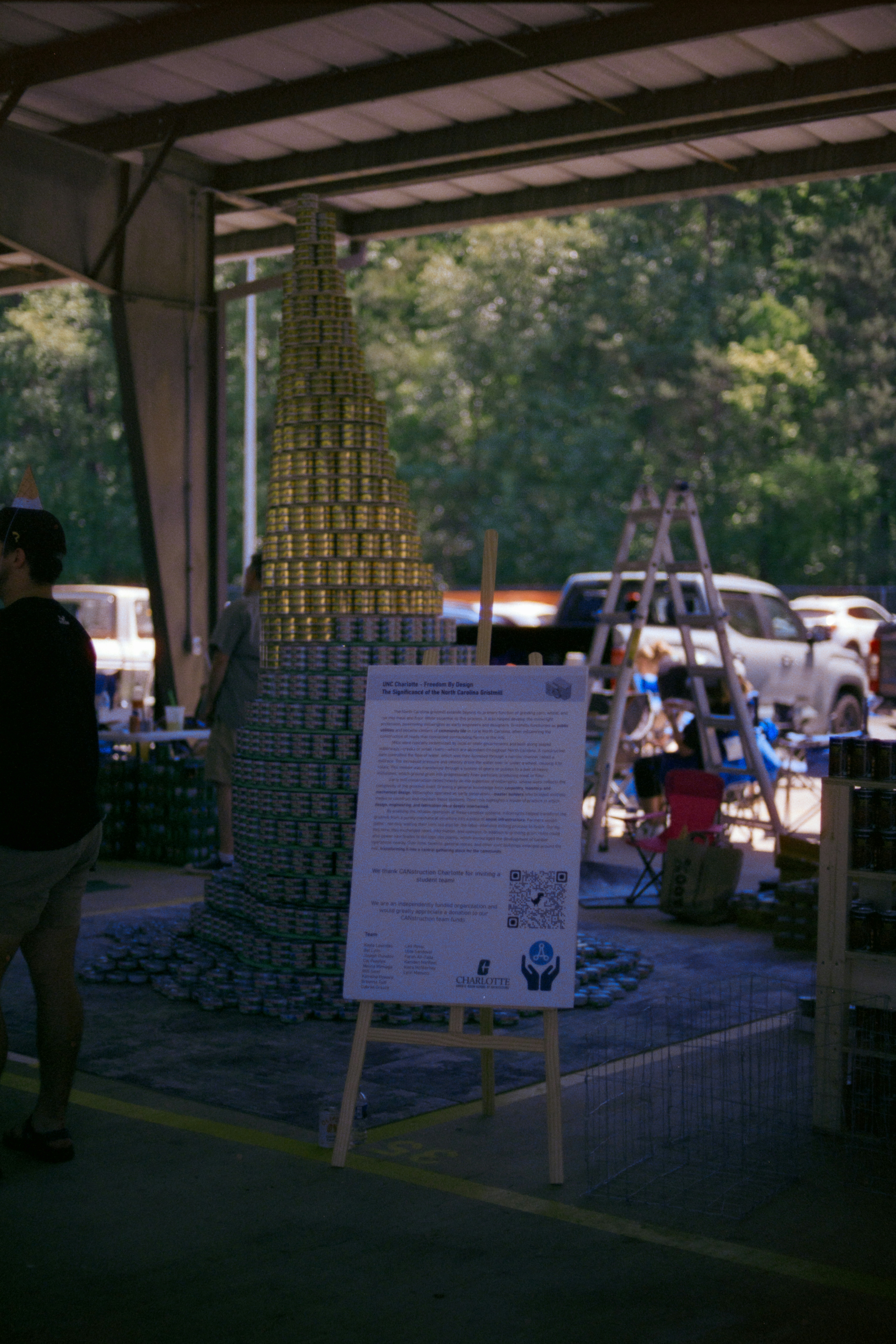 Stacked Puzzle of Tins: A Factory of Cans Under a Canopy