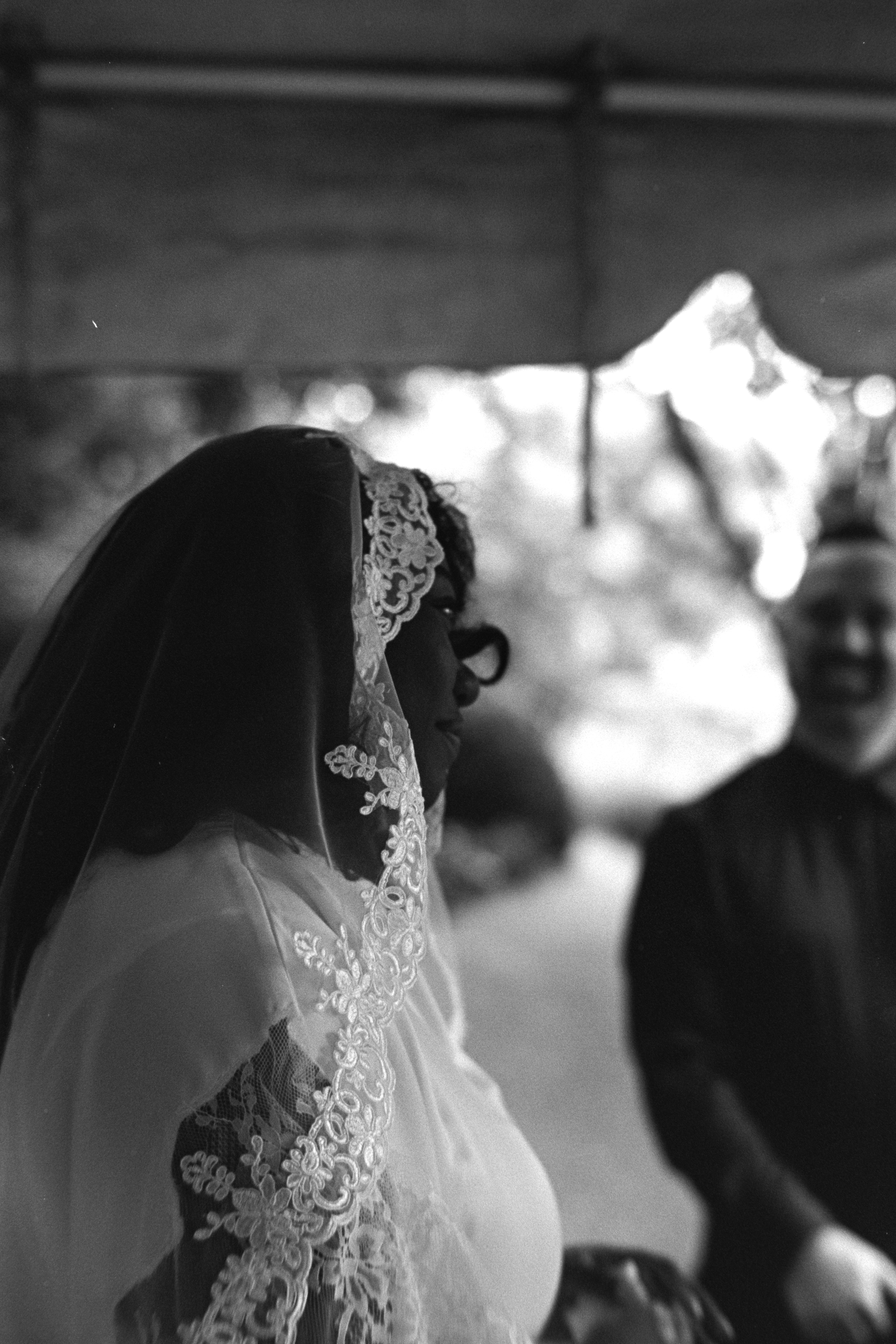 Woman in a wedding veil, black and white.