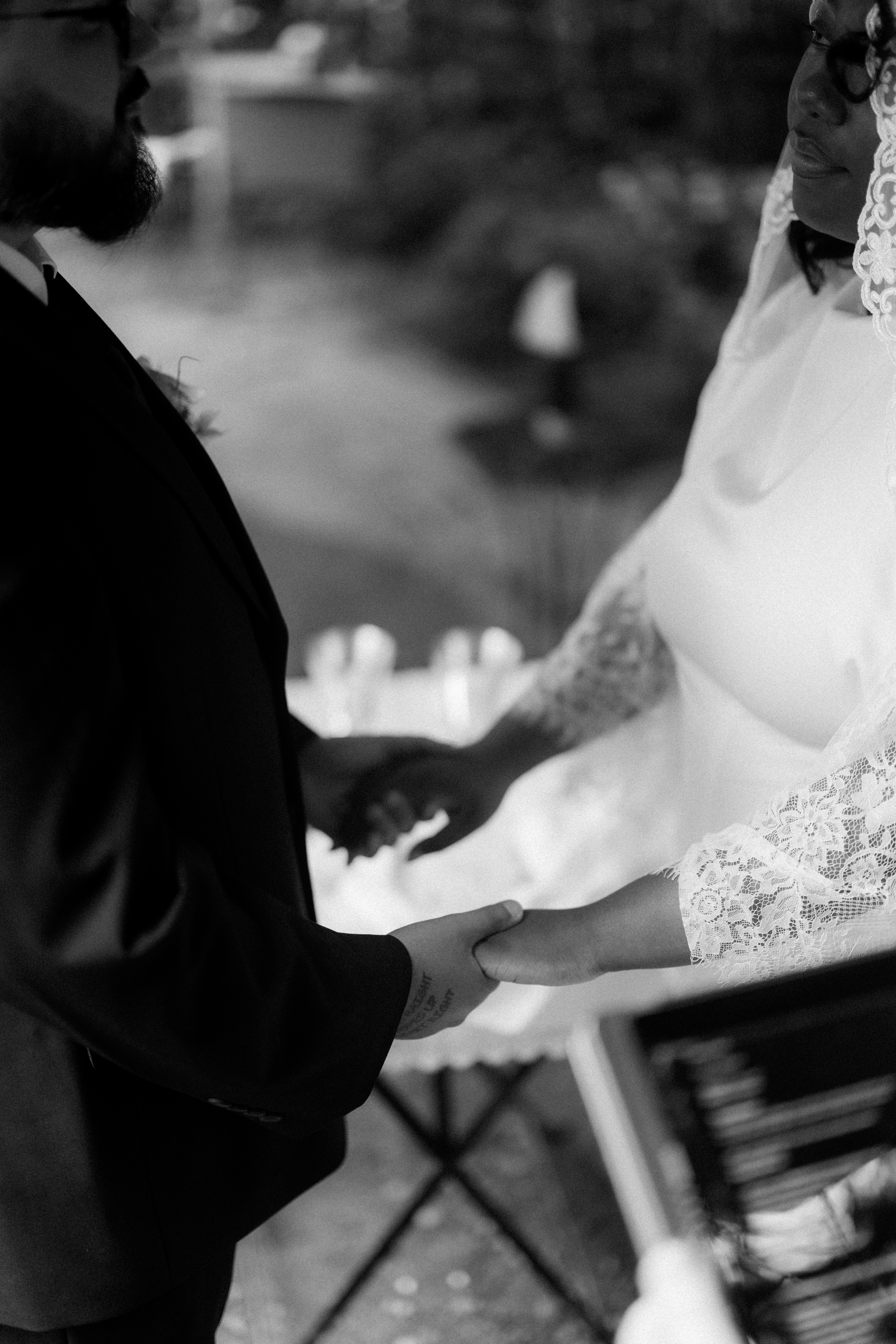 A bride and groom hold hands during their wedding ceremony.