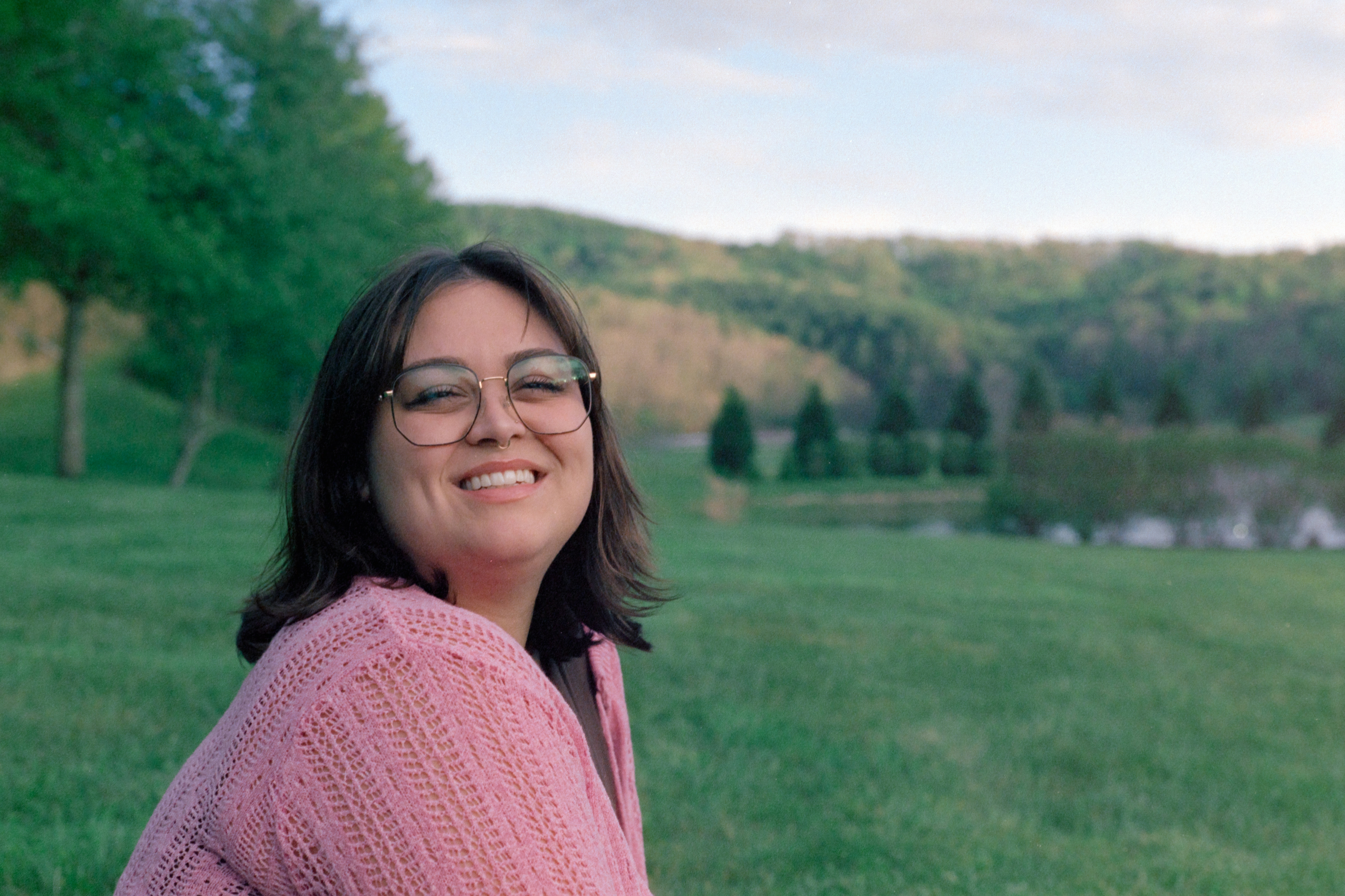Soft smile in a sunlit meadow