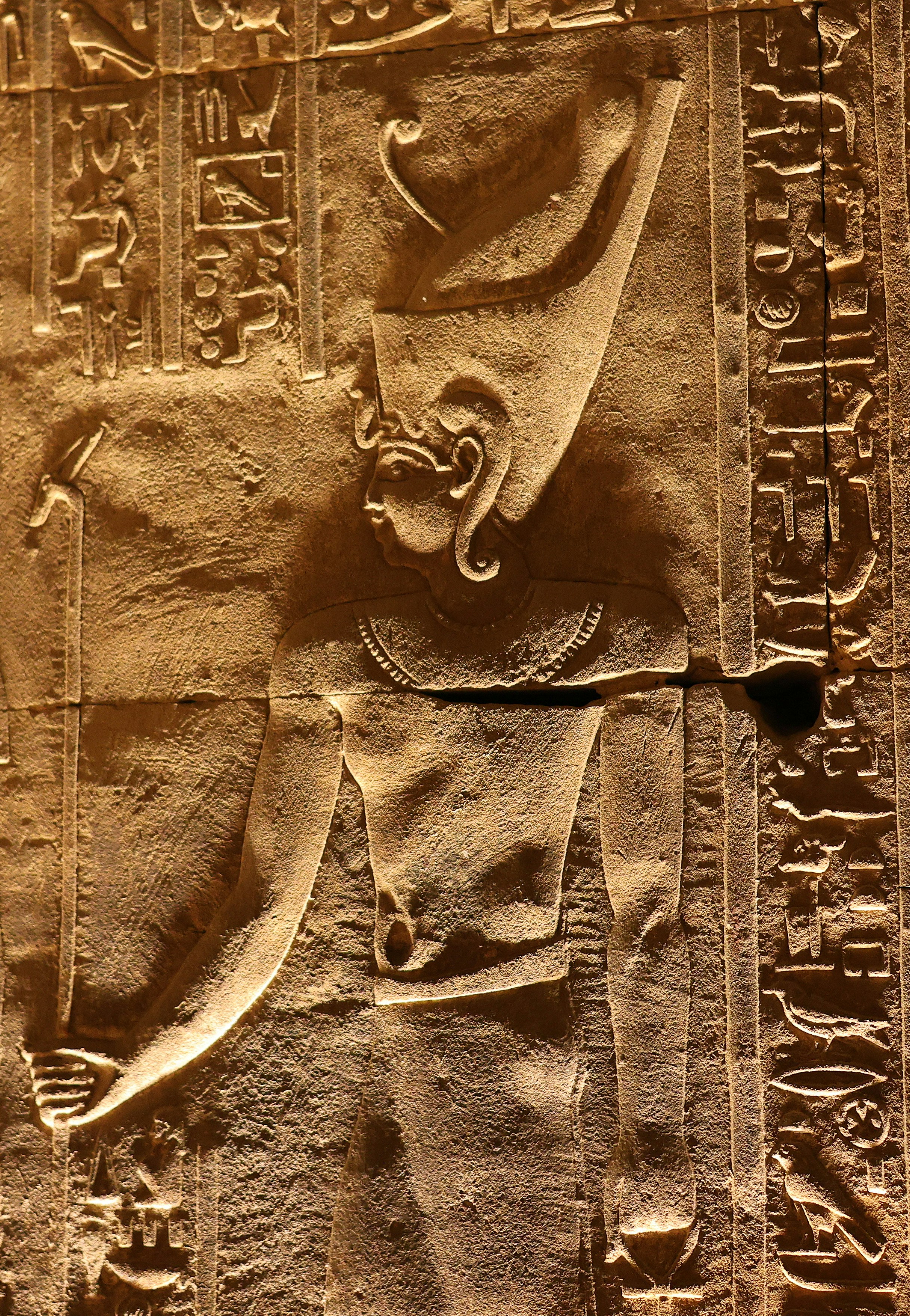 Sun-Drenched Amen-Ra Relief: A Seated Pharaoh in Carved Sandstone