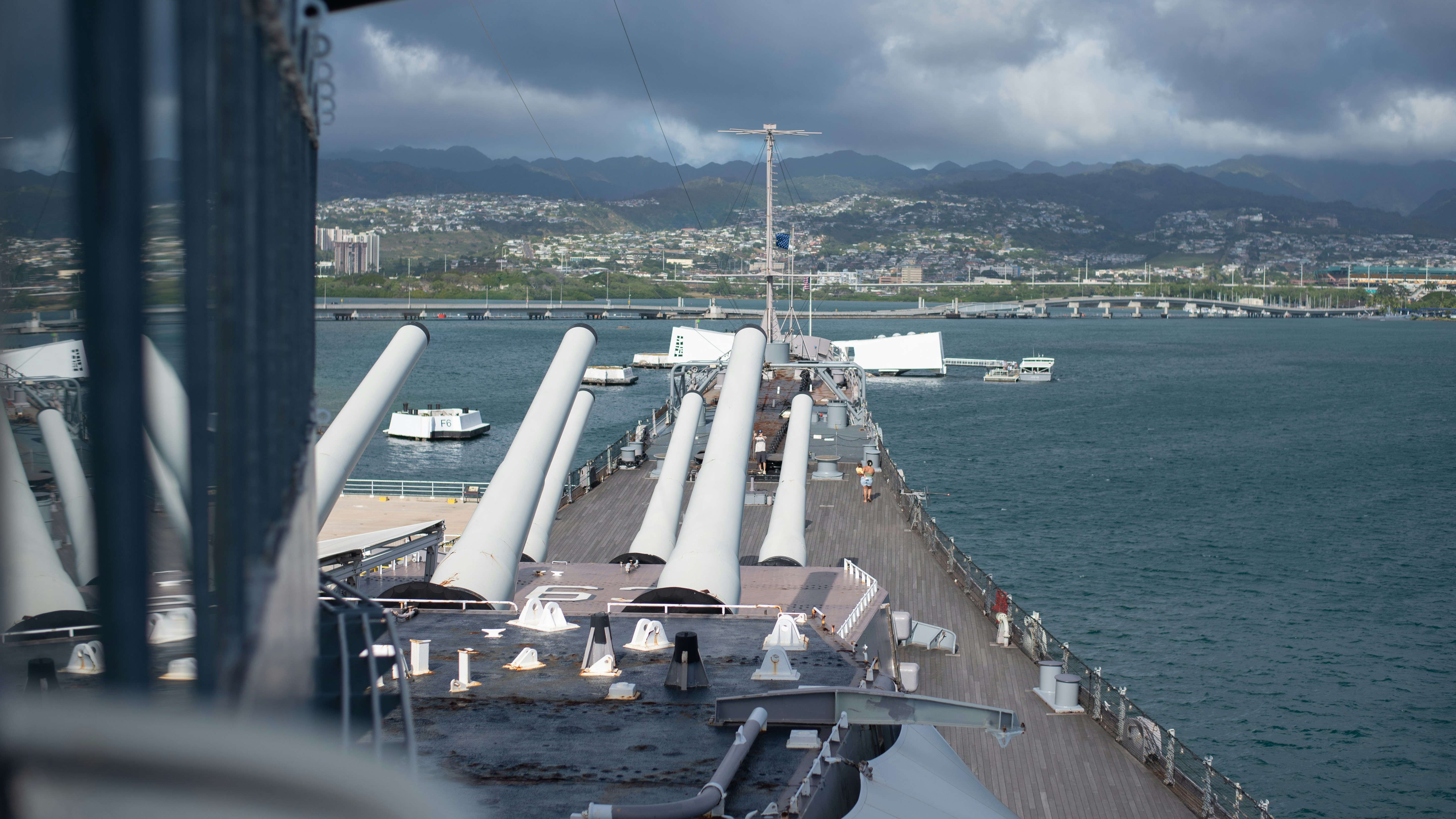 Pier Afloat: Distant Bay and Mountain Range Beyond a Modern Terrace