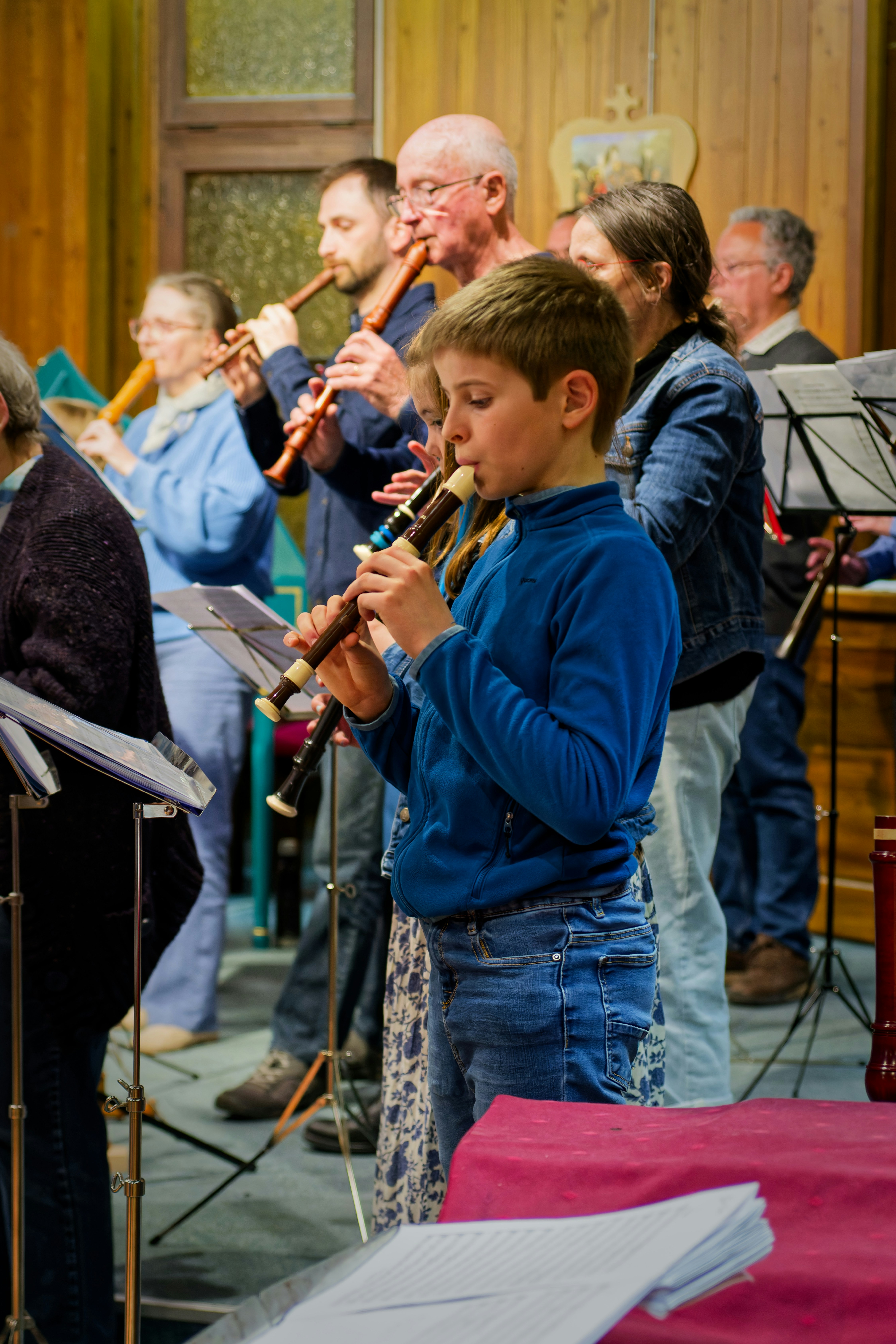 Youth Clarinetist at the Foreground: A Family Ensemble in a Warm Wooden Hall