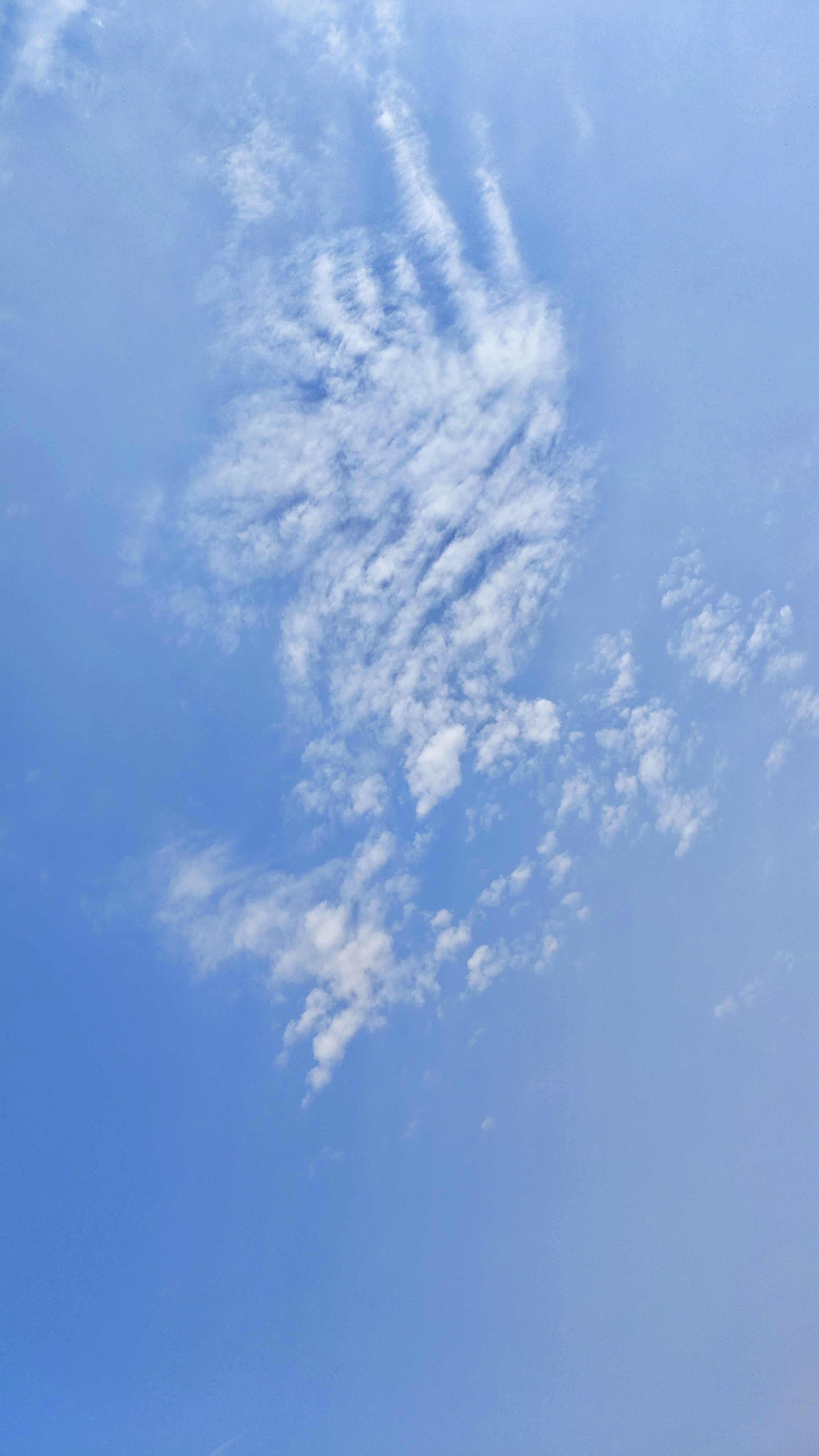 Azure Sheen: A Skyward Wake of Clouds