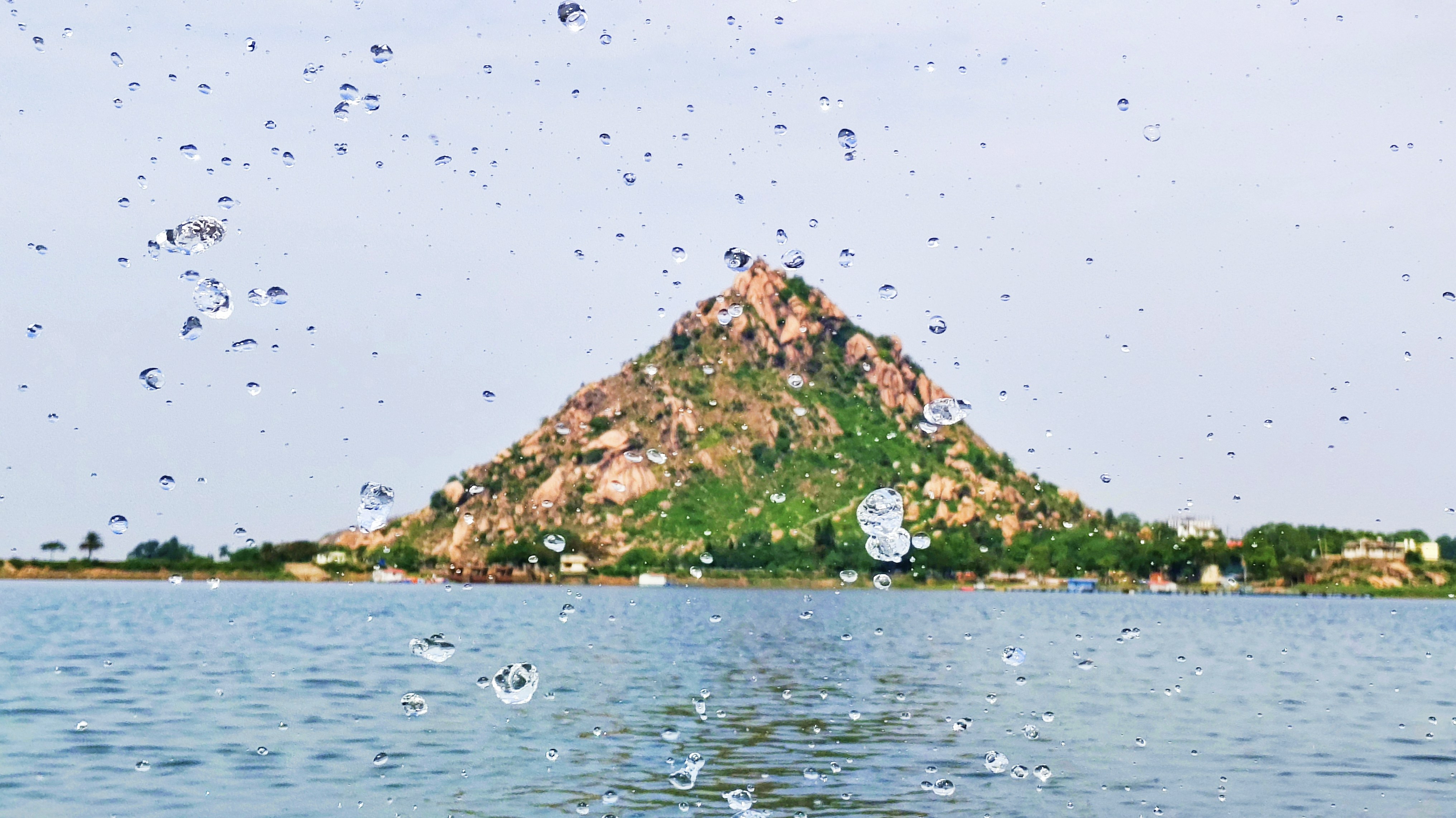 Misty Island Peak Emerging from a Splashing Sea