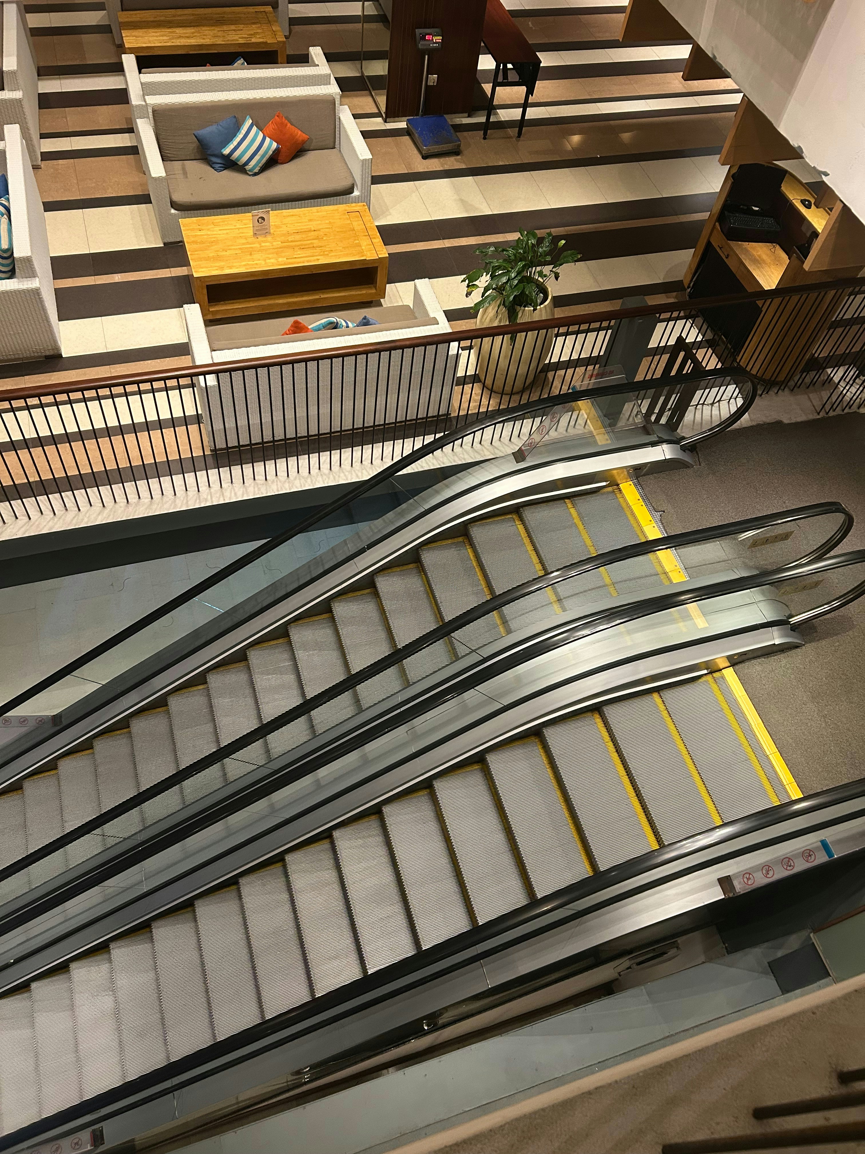 Aerial View of an Ascending Atrium: Escalators and Lounge Zones