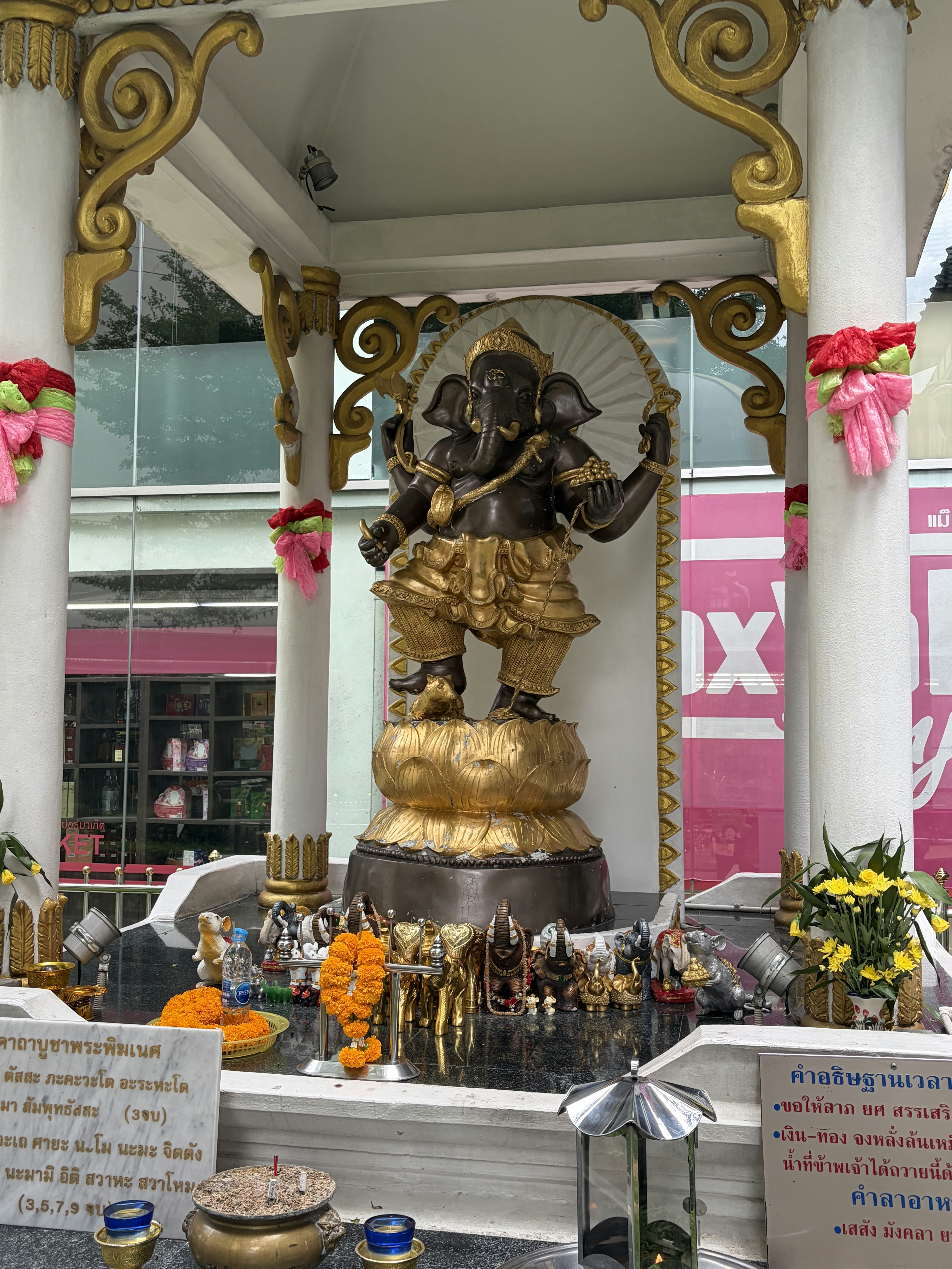 Gilded Ganesh Shrine: A Central Bronze Lord Among Offerings