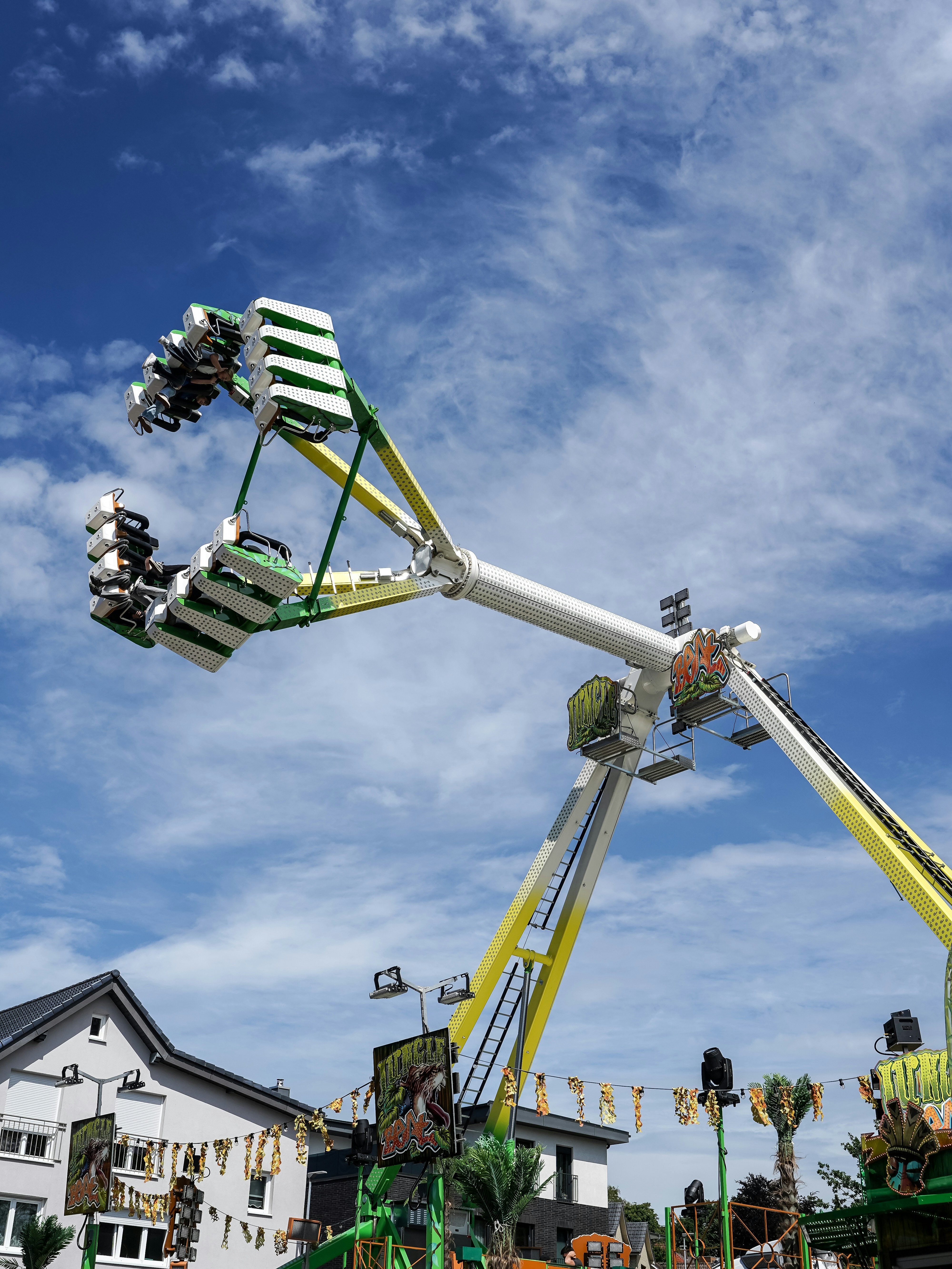Arc of Adventure: Swinging Gondolas Against a Scattered Sky