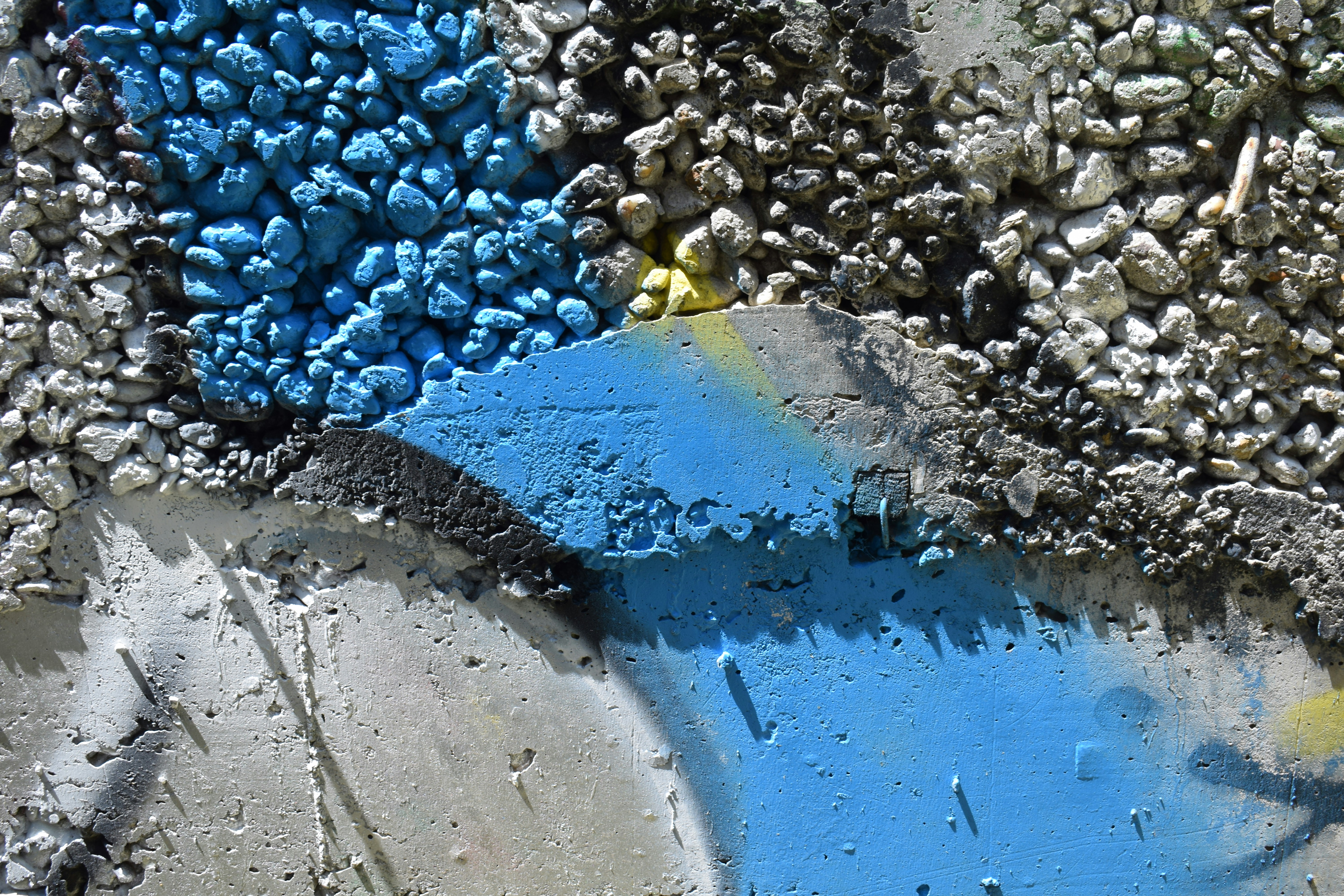 Spray-Painted Texture: Blue and Gray Gravelled Wall with Concrete Slices