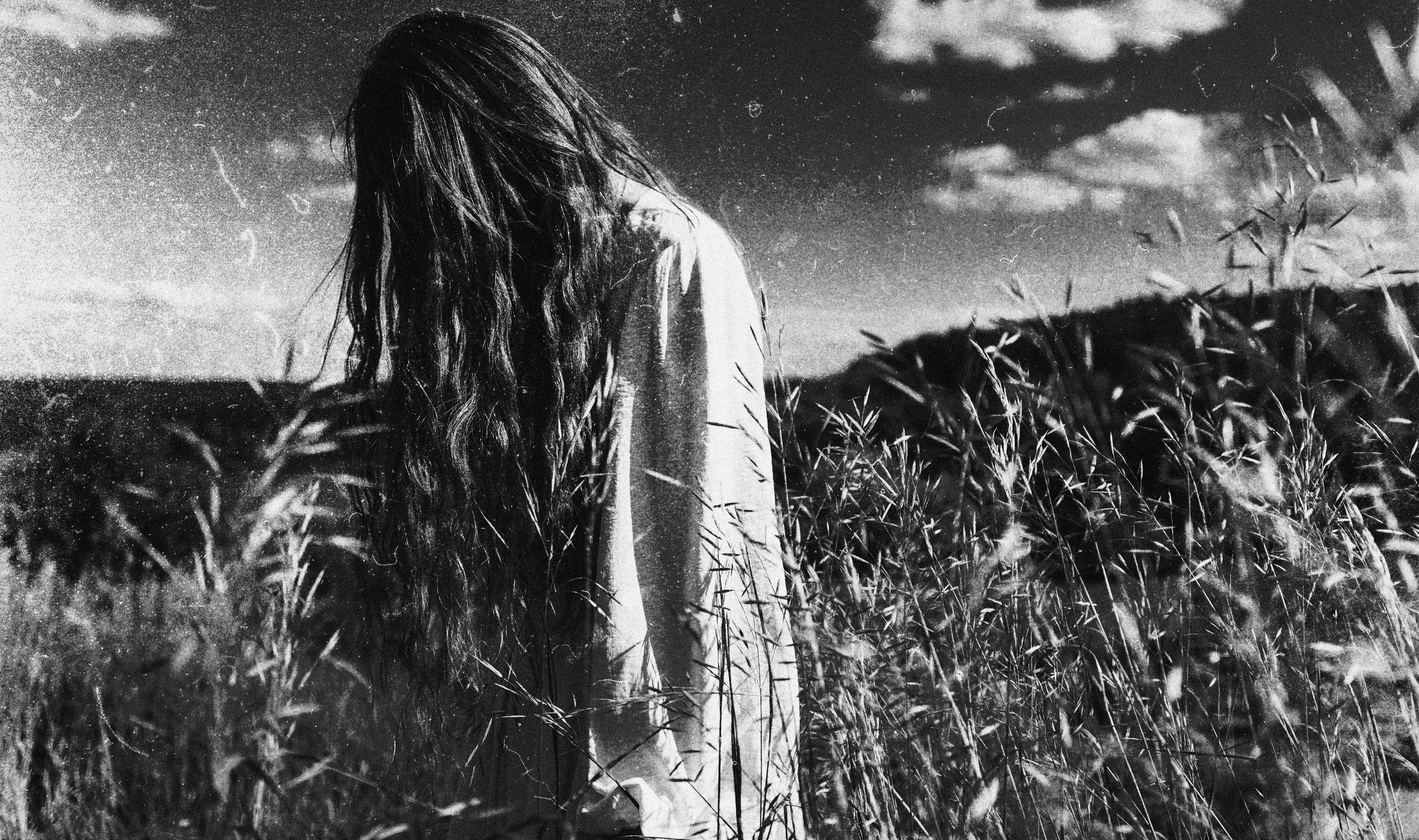Portrait in Tall Grass: A Lone Figure in Monochrome Field