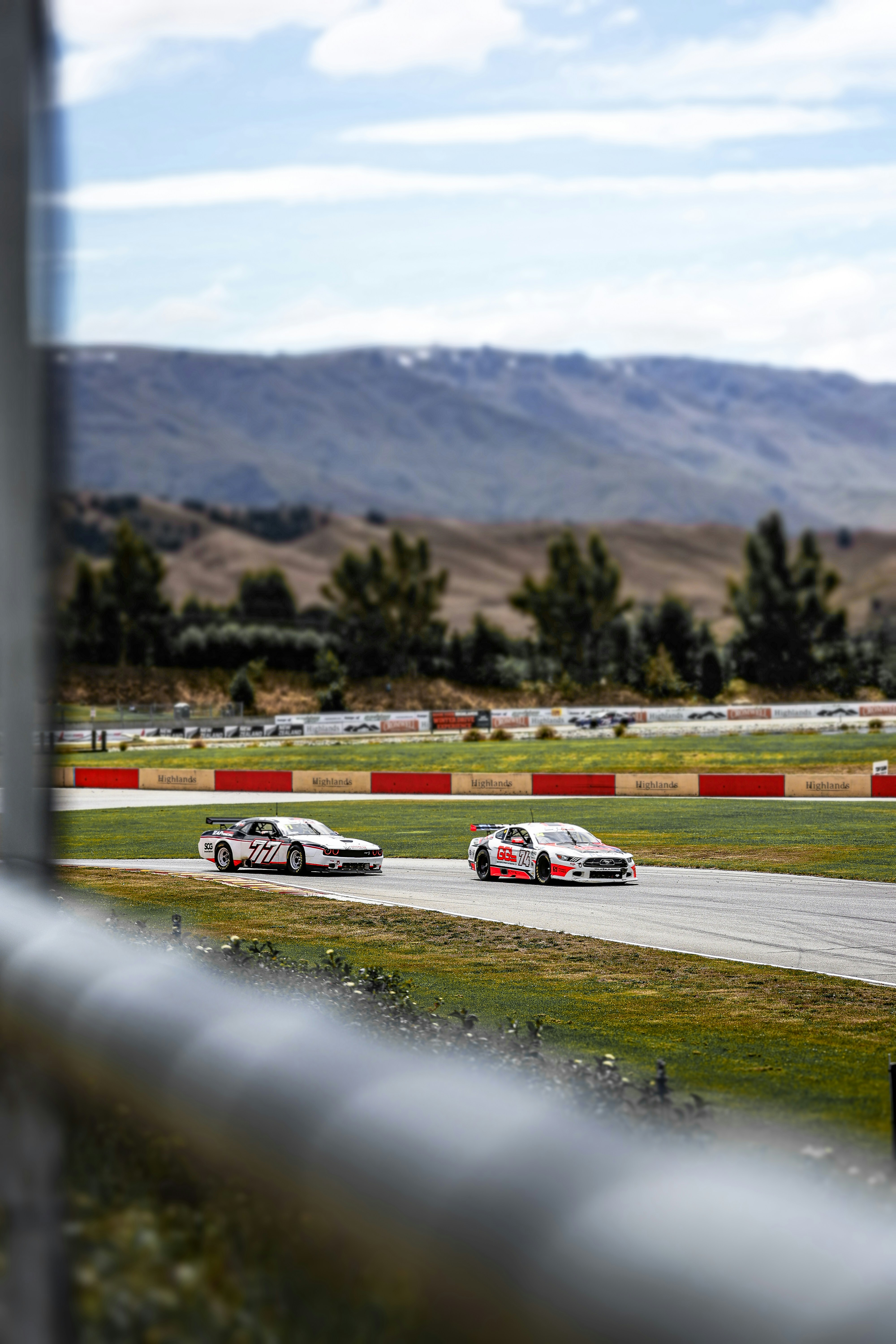 Racecraft on the Open Track: Two White Cars in a Tilted Arc