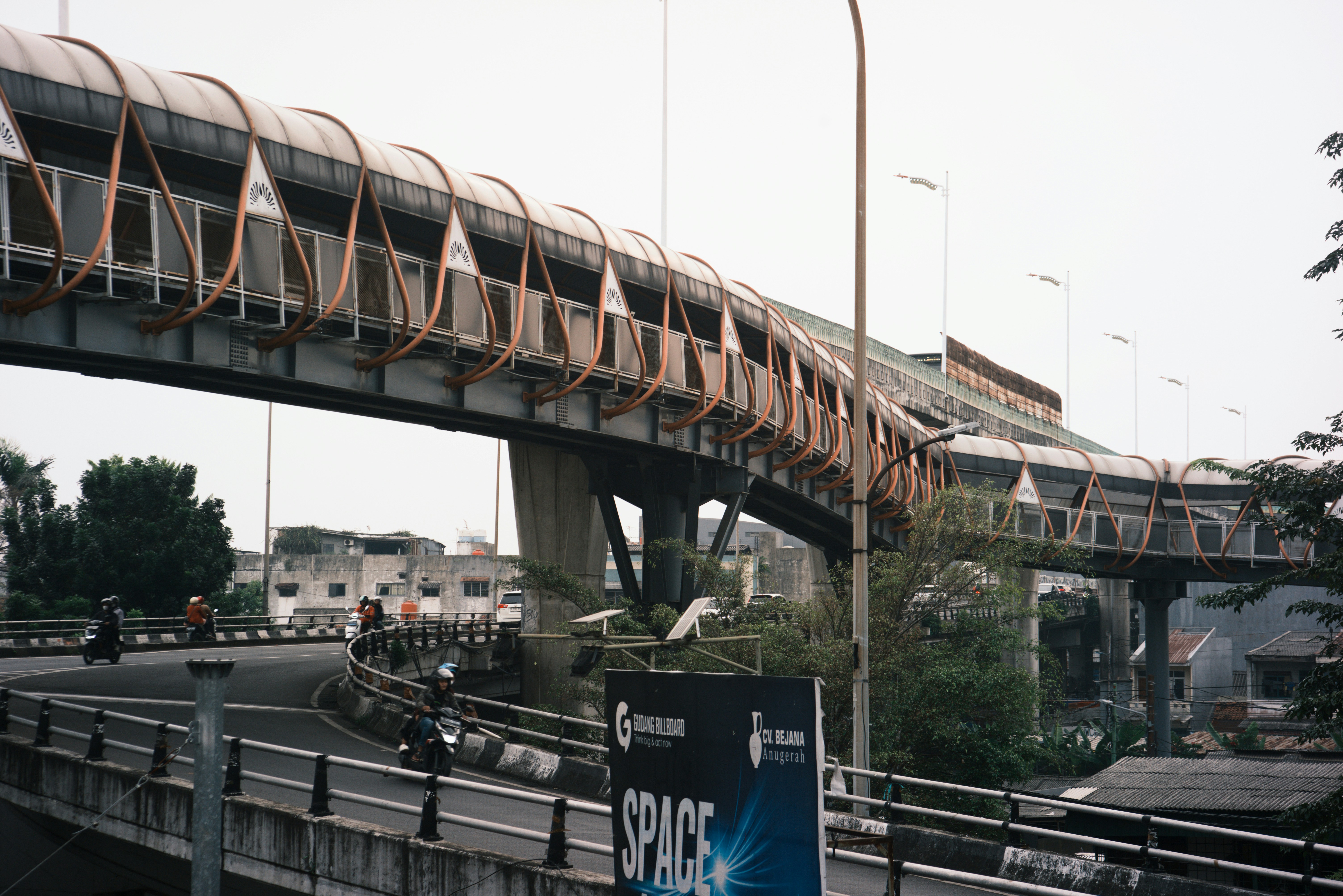 Overpass Ribbon: A City Bridge Framed by Curved Steel and Quiet Sidewalks