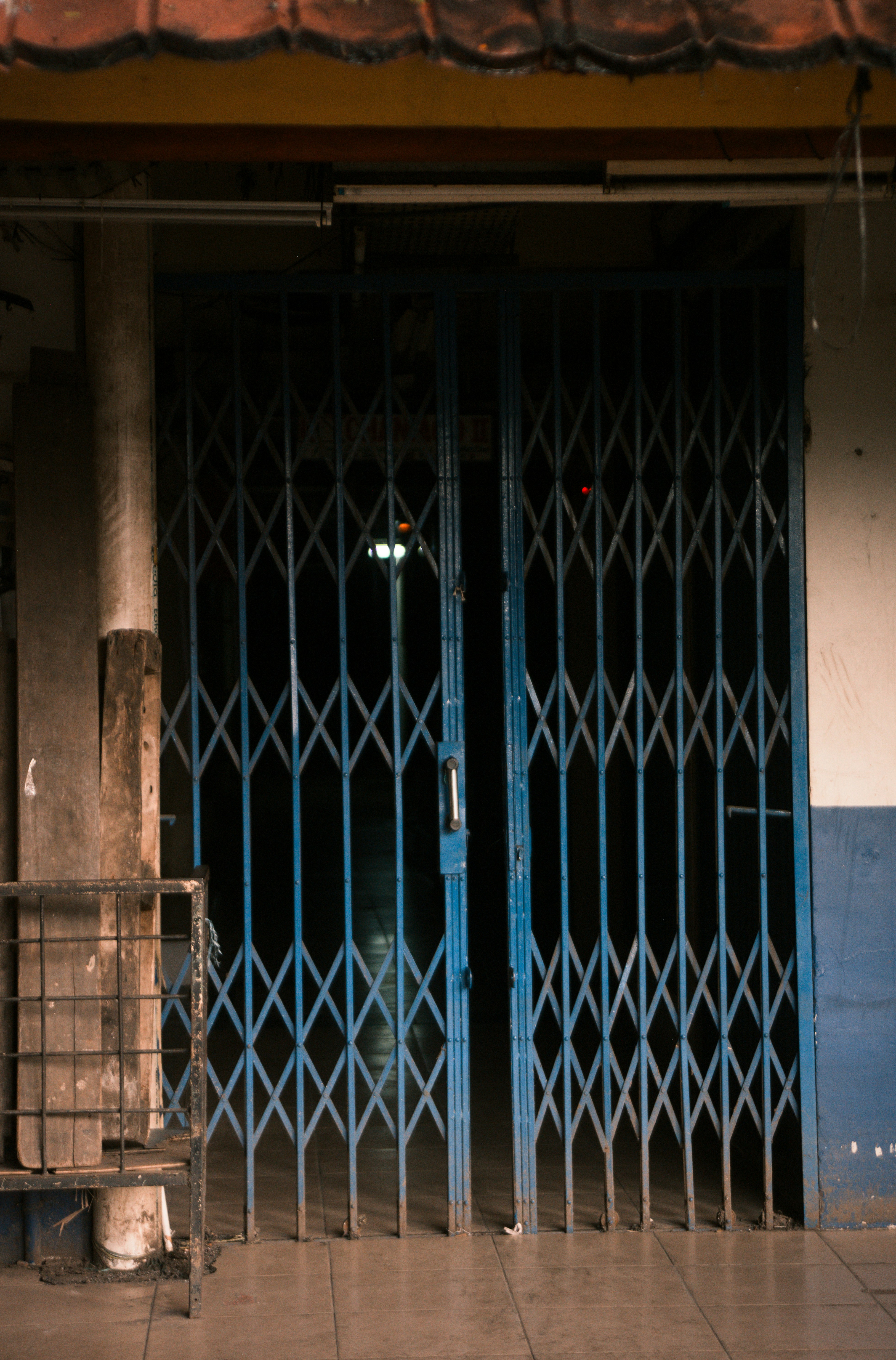 Blue Gate at Dusk: A Quiet Street Veil of Metal and Shadow