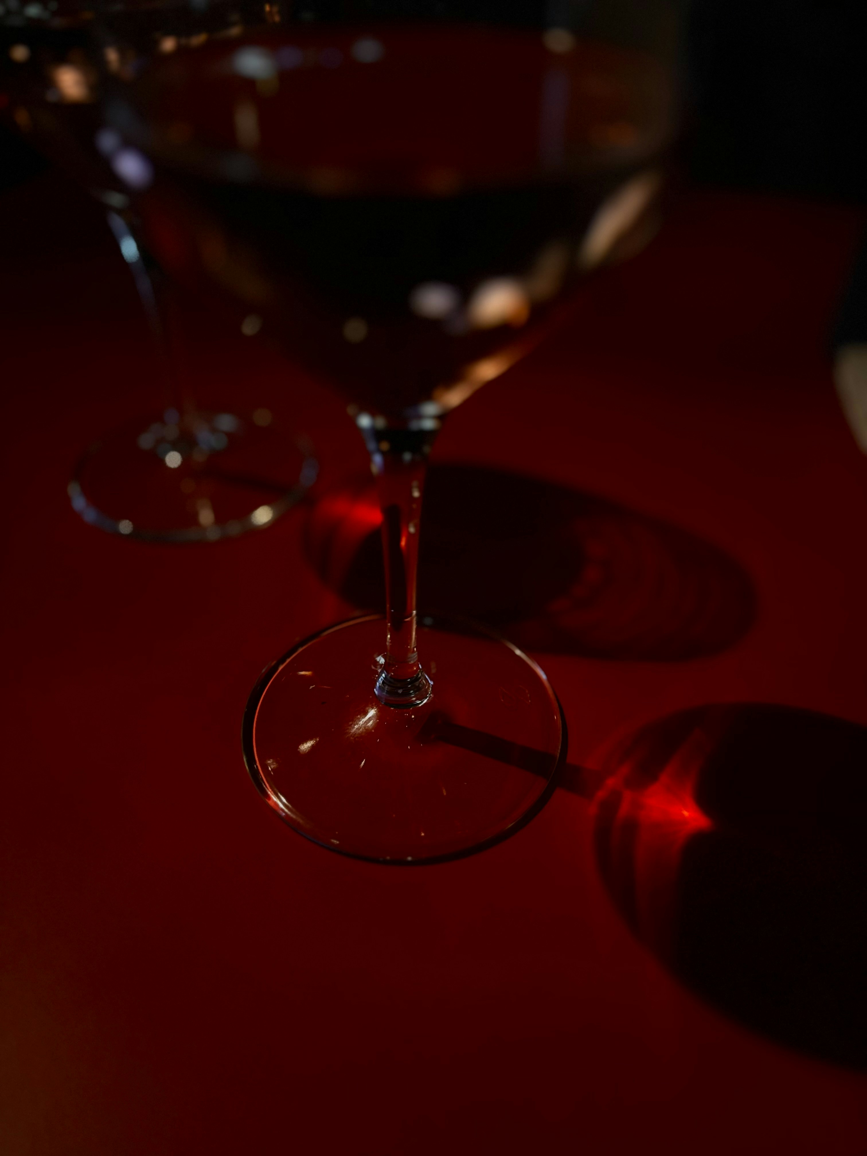Crimson Glow: a lone wine glass on a shadowed table