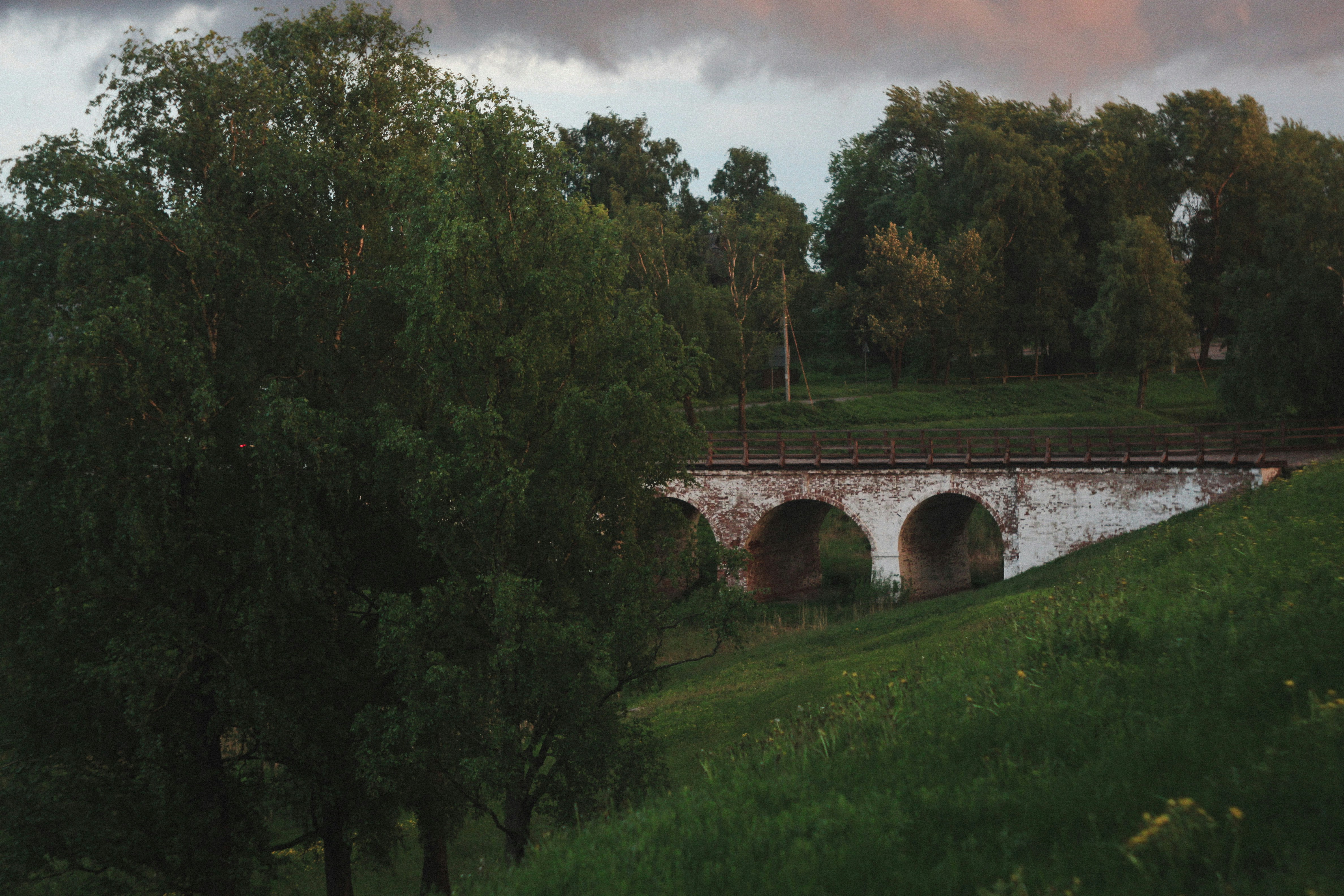 Old Stone Bridge Nestled in a Quiet Riverbank Meadow