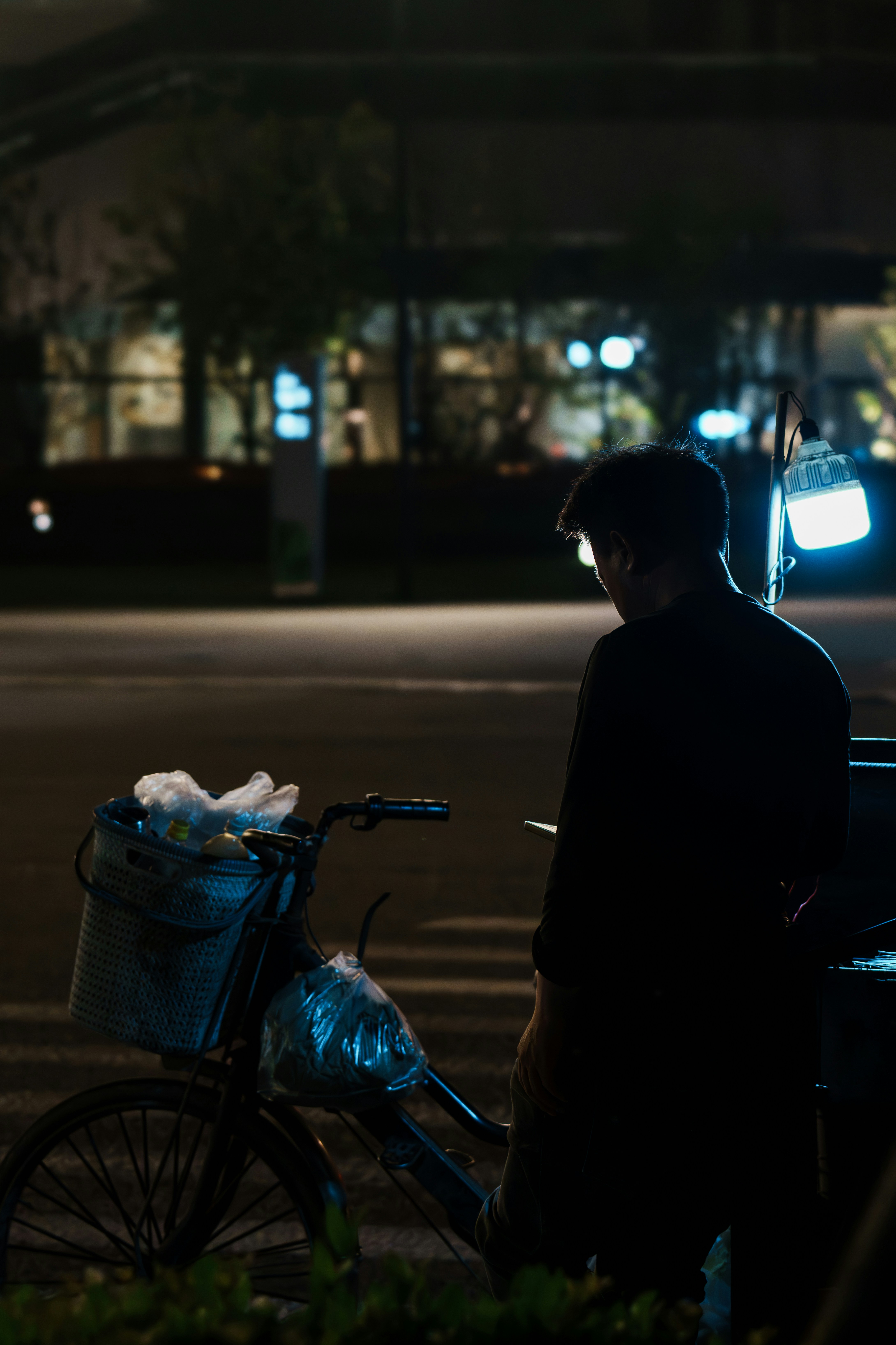 Midnight Quiet: A solitary bike and silhouette under neon dusk