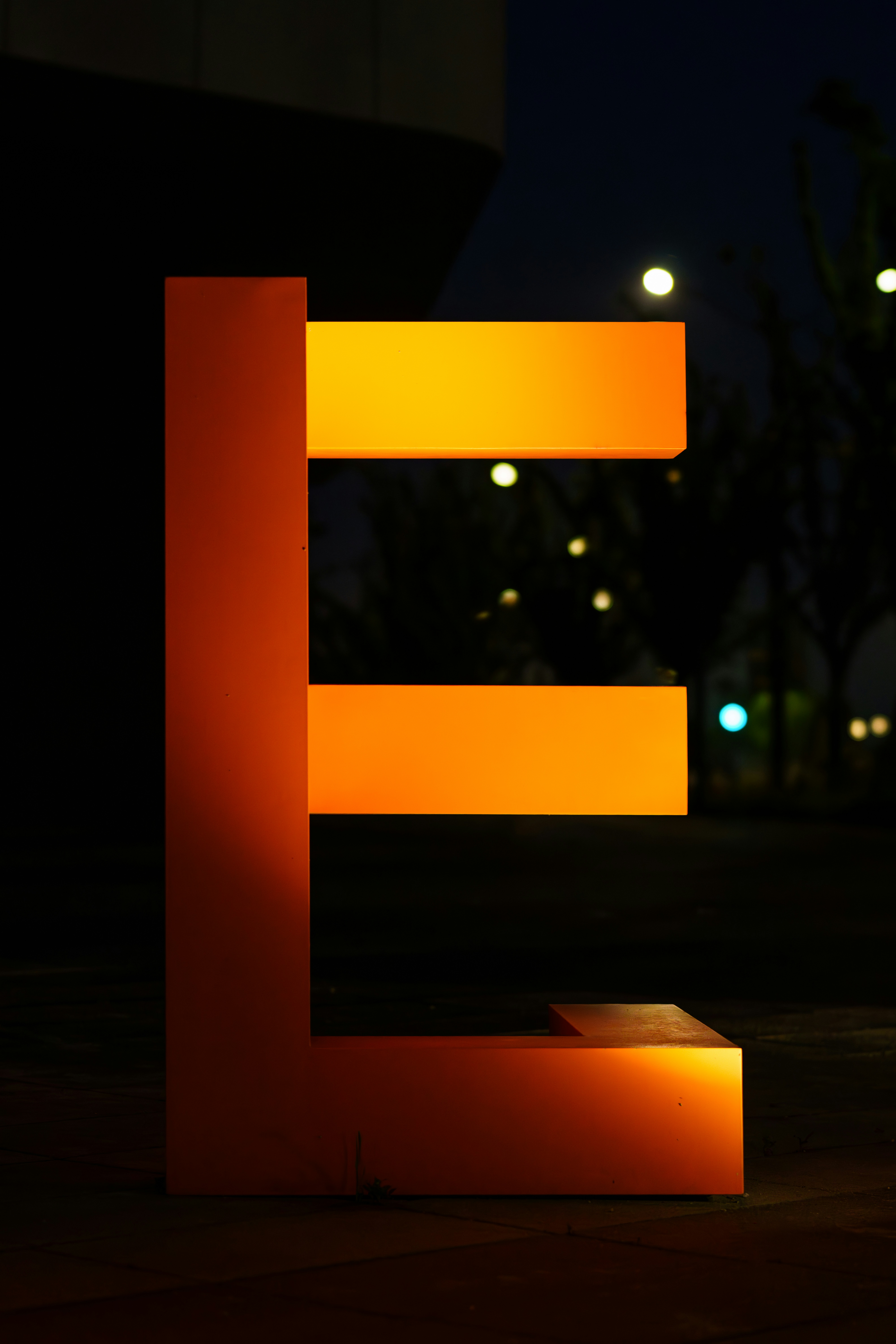 Neon Letter E Bathed in Night Orange