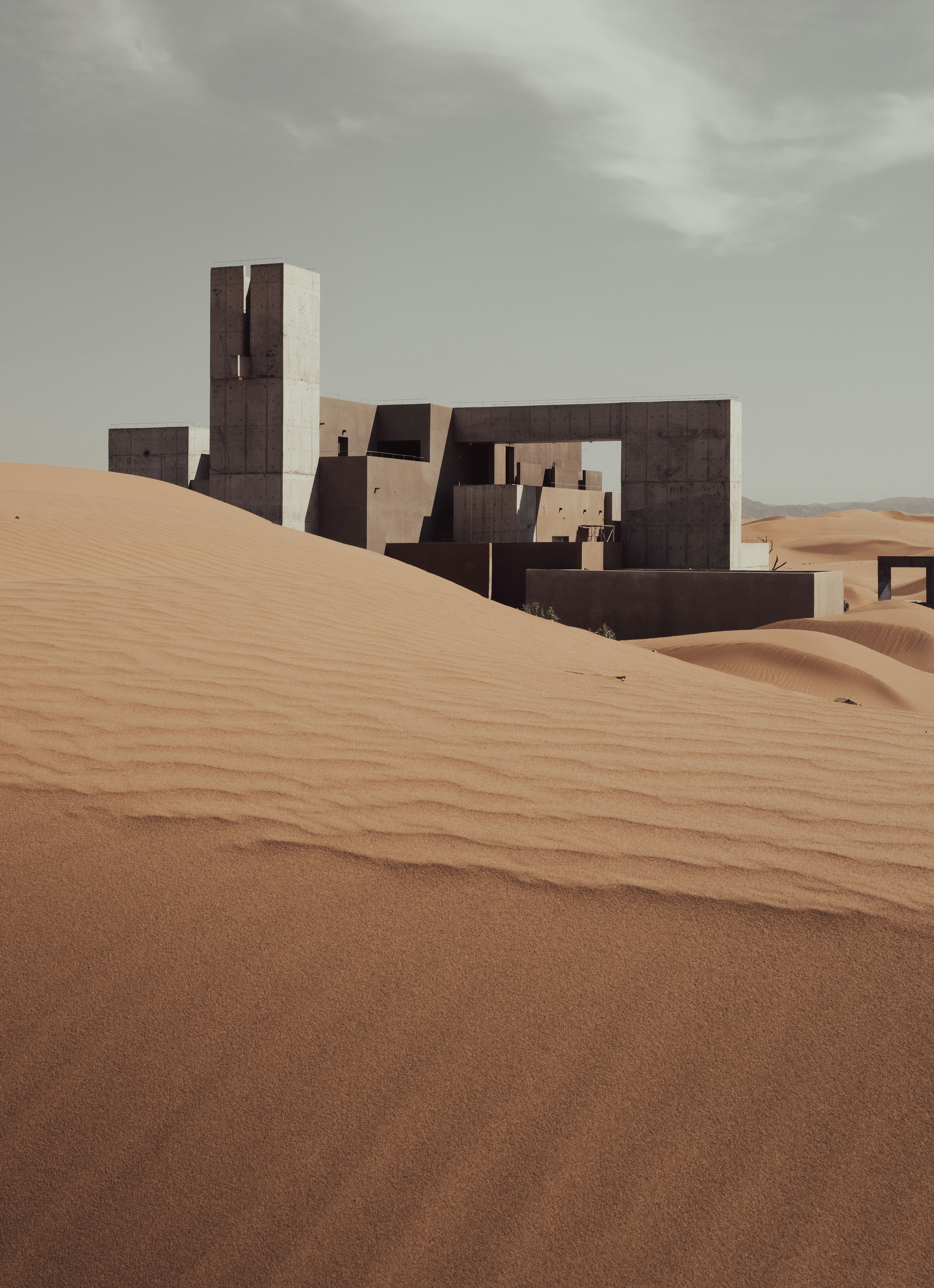 Desert Fortress: Geometric Shadows Rise from Golden Dunes