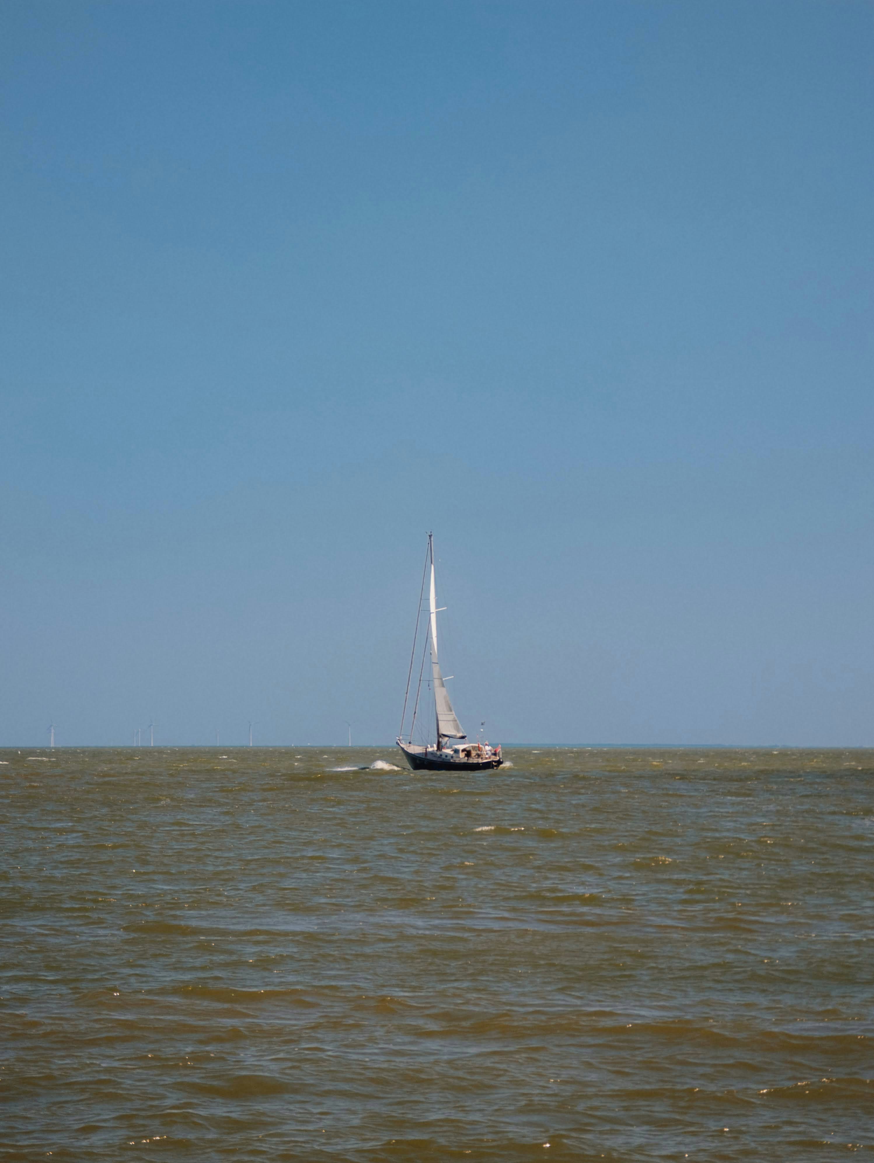 Lonely Sailboat on a Quiet Horizon