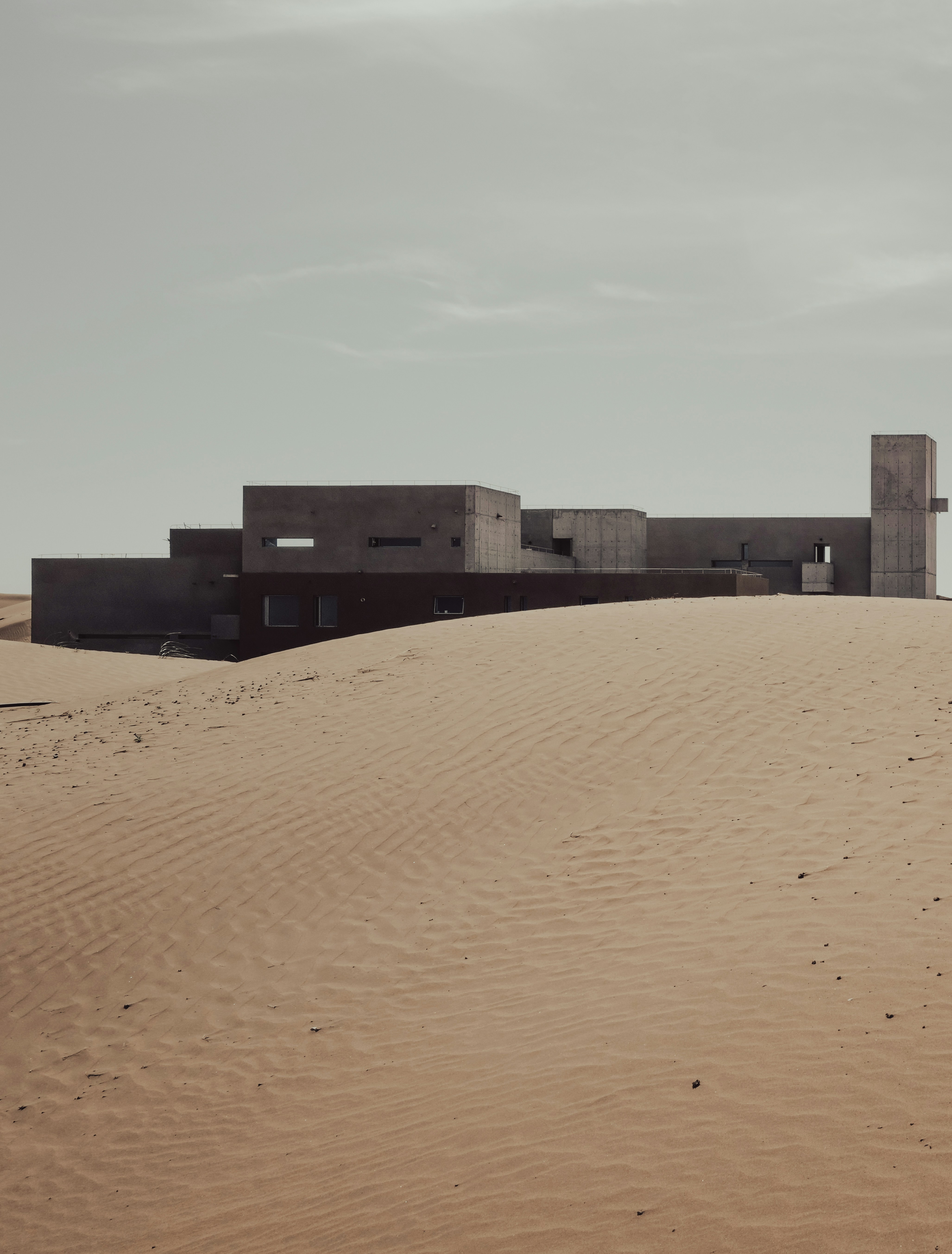 Deserted Monolith: Concrete Geometry Rising from Dunes