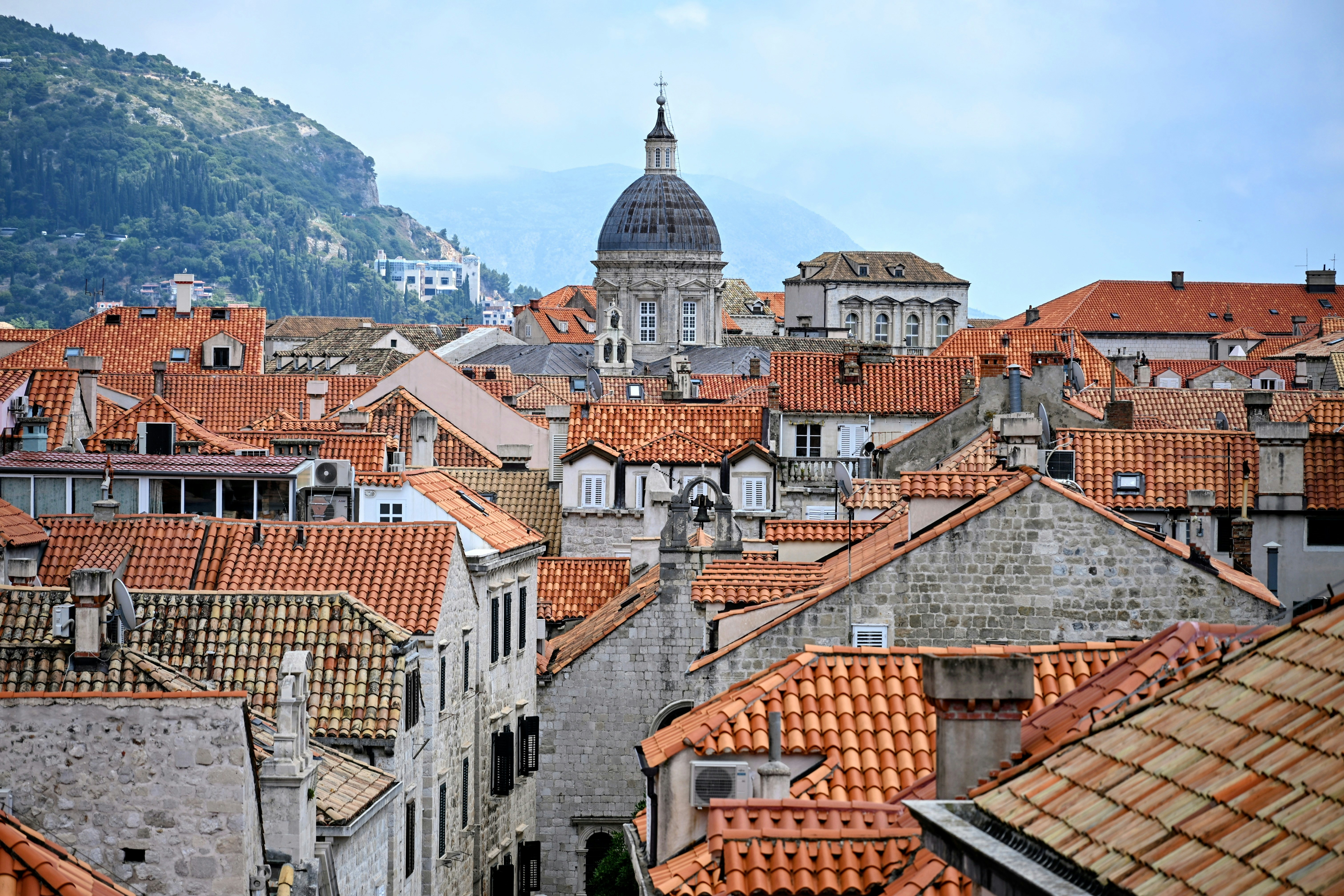 A sea of terracotta rooftops stretches across Dubrovnik's UNESCO-listed Old Town, framed by historic stone buildings and the city's distinctive Baroque skyline.