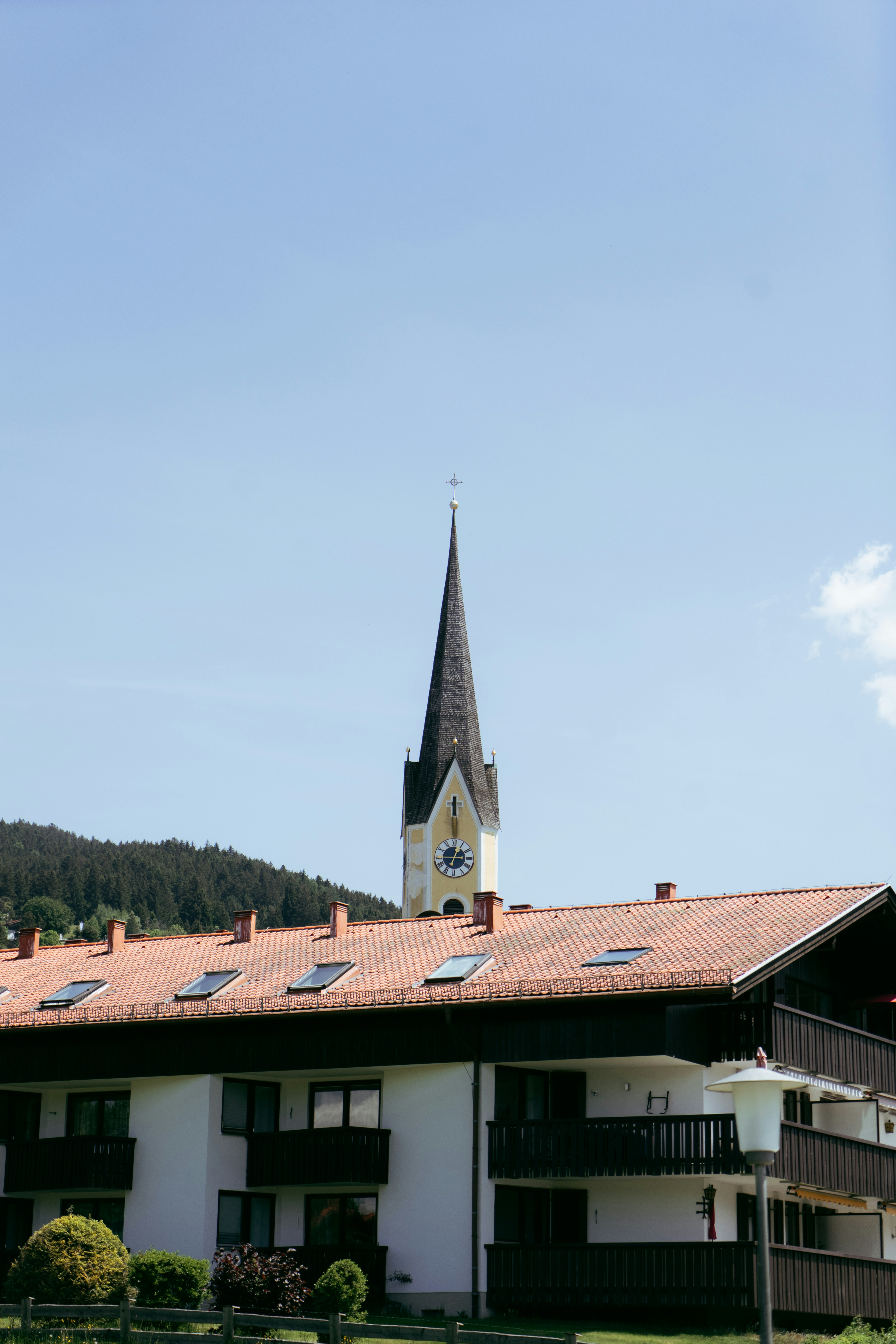 Spire Amidst Red Rooflines: A Quiet Alpine Village