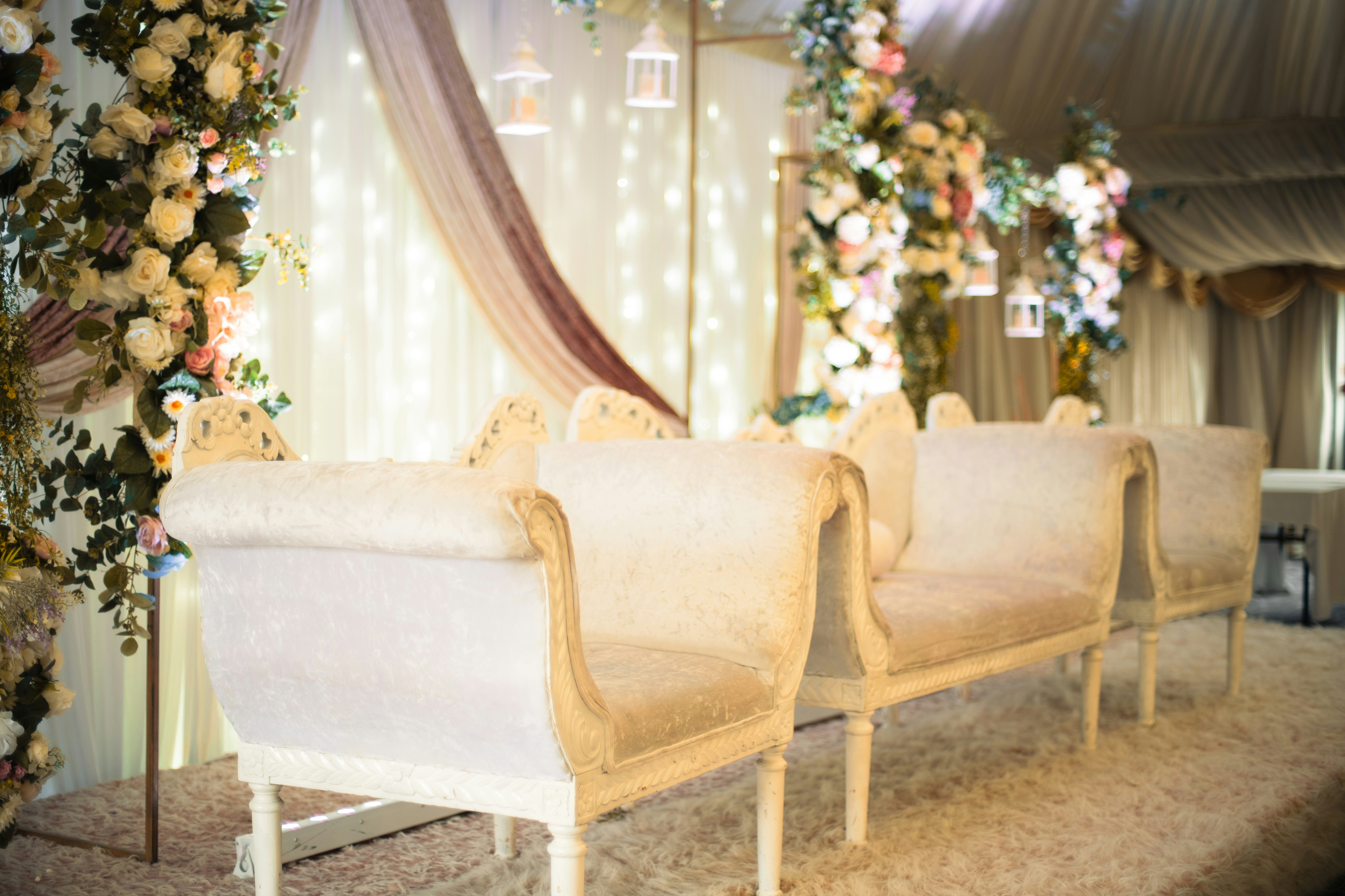 Floral Arc Over Velvet Seats: A Wedding Stage Portrait