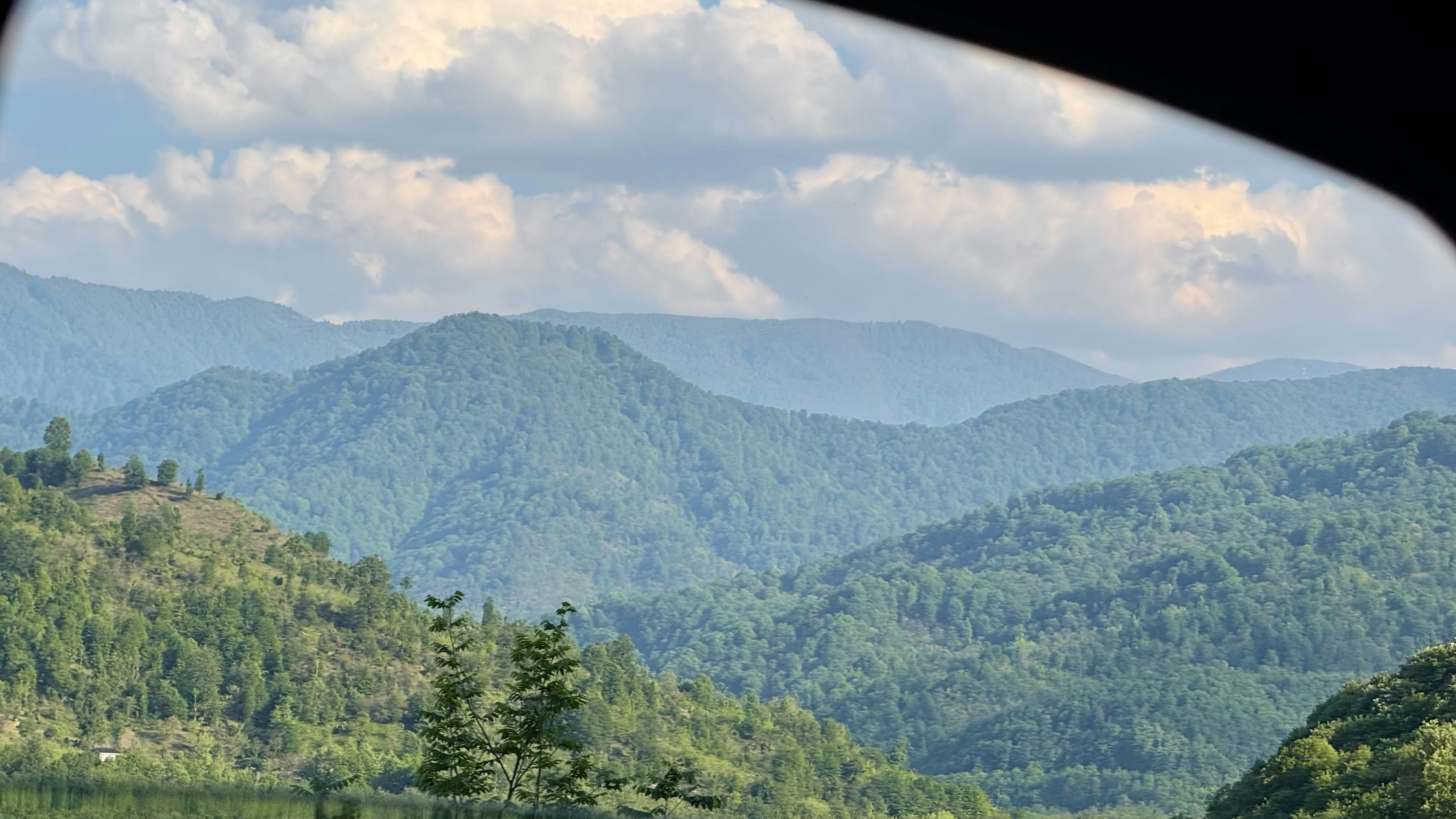 Layered Blue Ridges Beyond a Gentle Valley Horizon