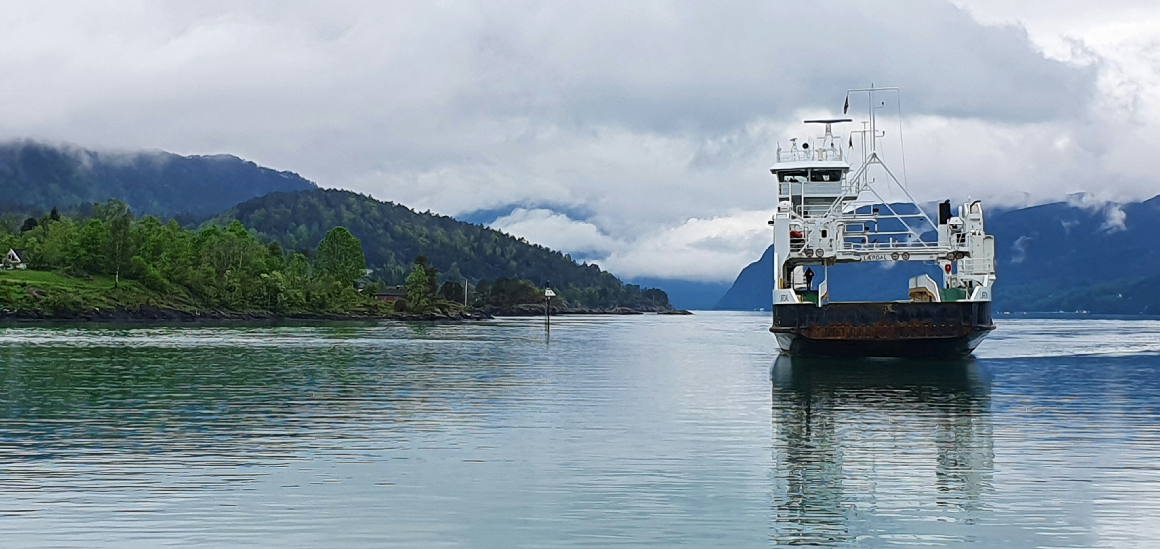 Harbor Grasp: A lone ferry anchored in a glassy fjord