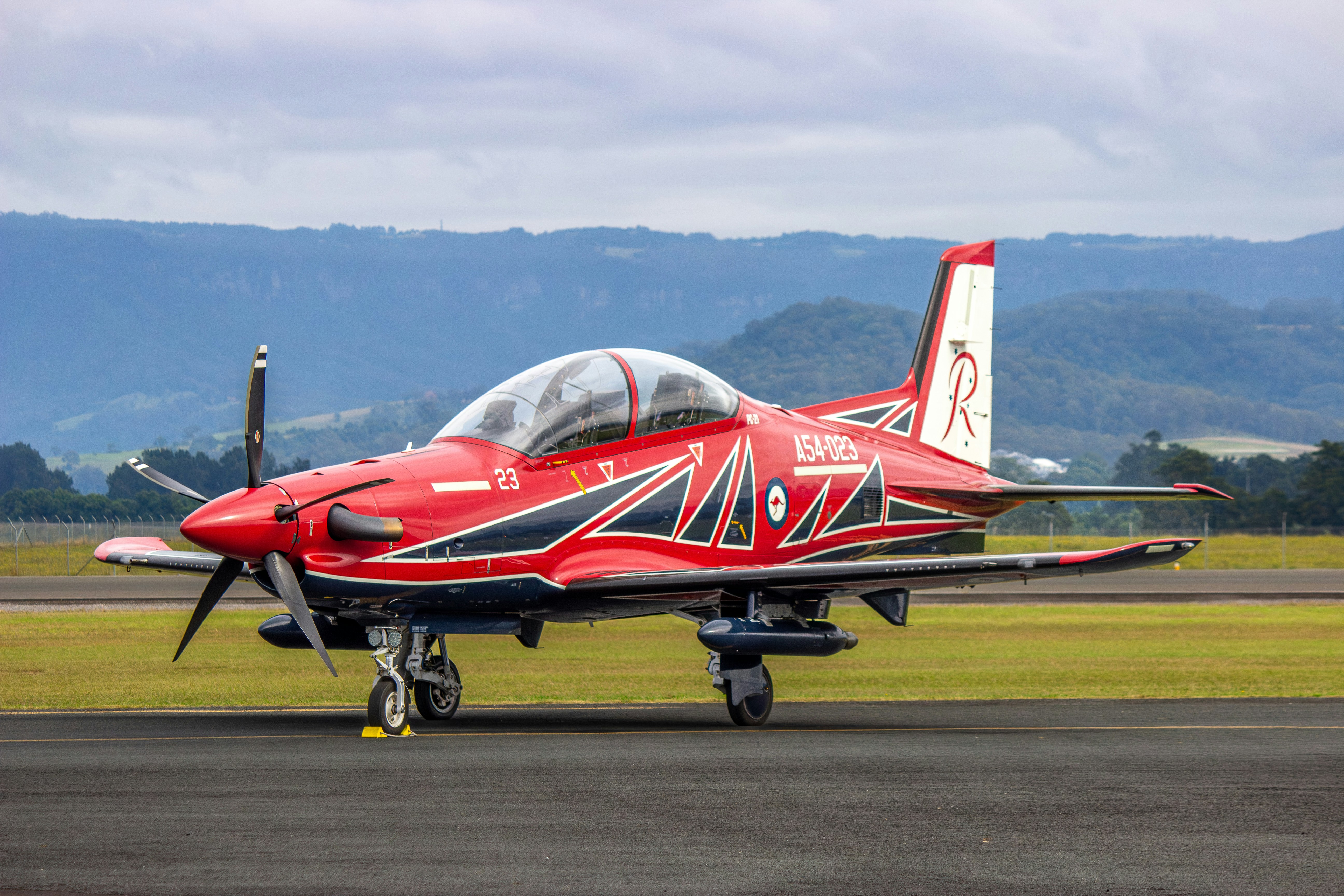 Red Aerobatic Star on the Tarmac: The Markings and Profile of a Crimson Jet
