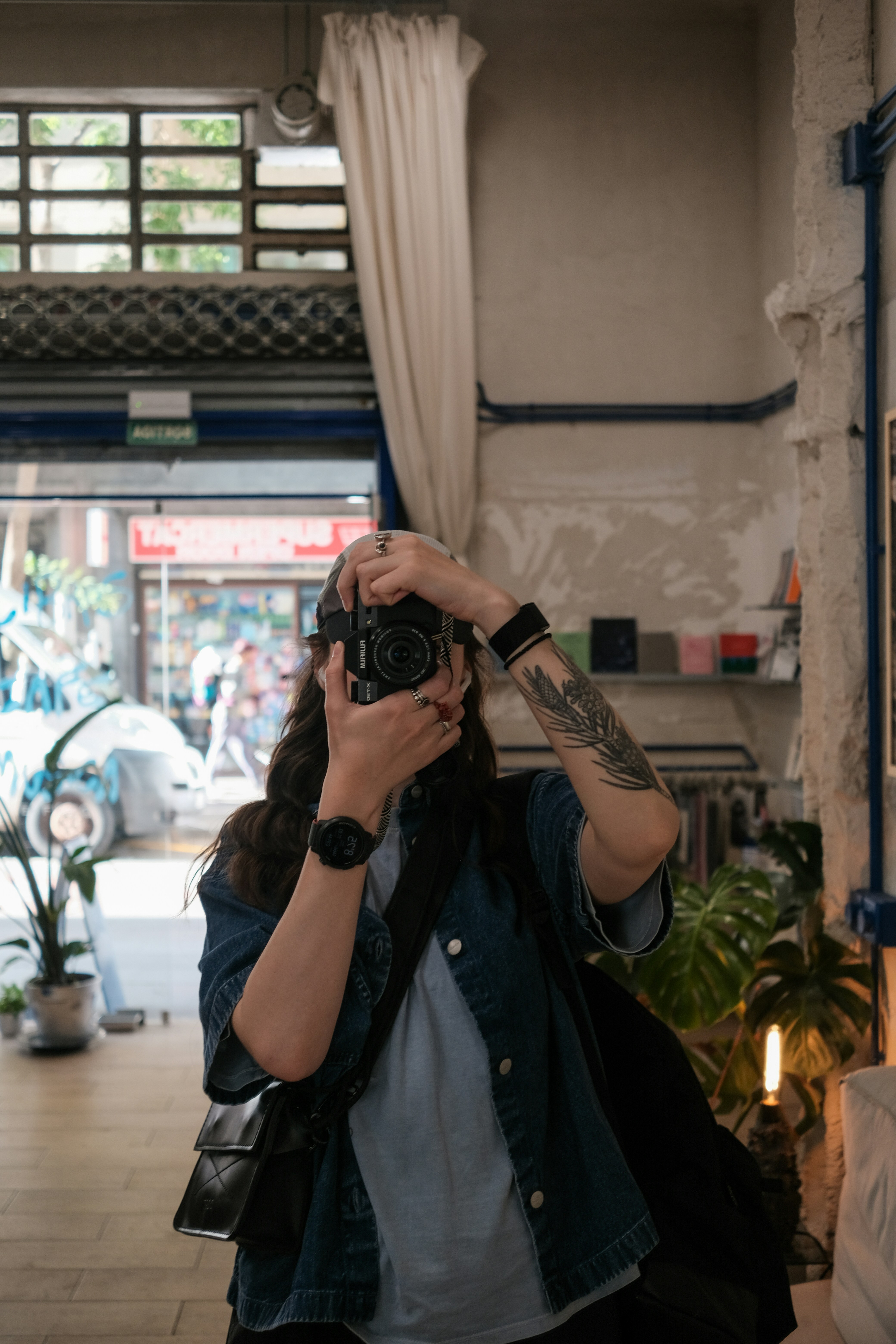 Behind the Lens: A Portrait in a Sunlit Studio Corridor