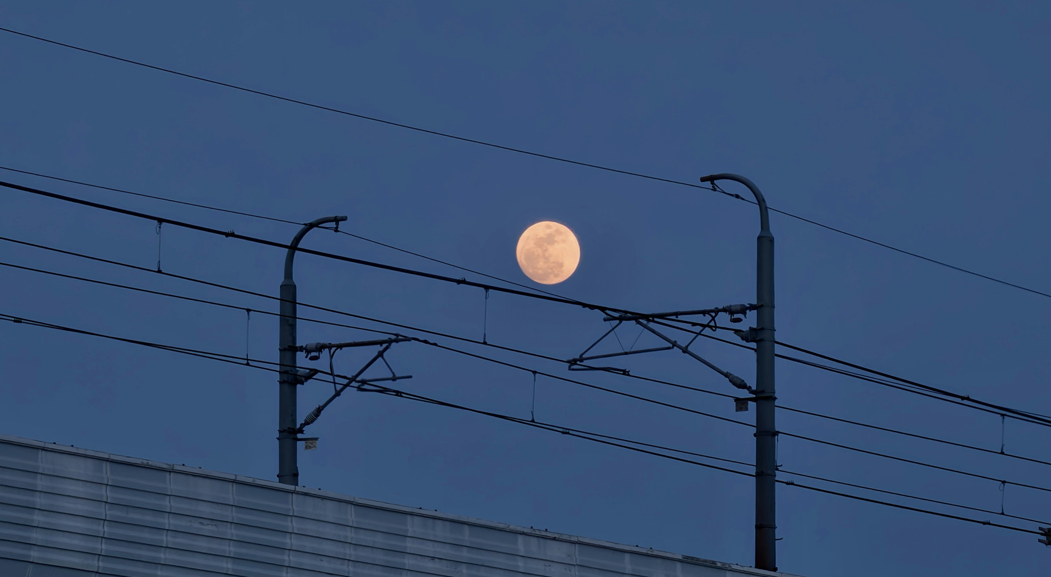 Luminous Moon Over the Urban Skyline