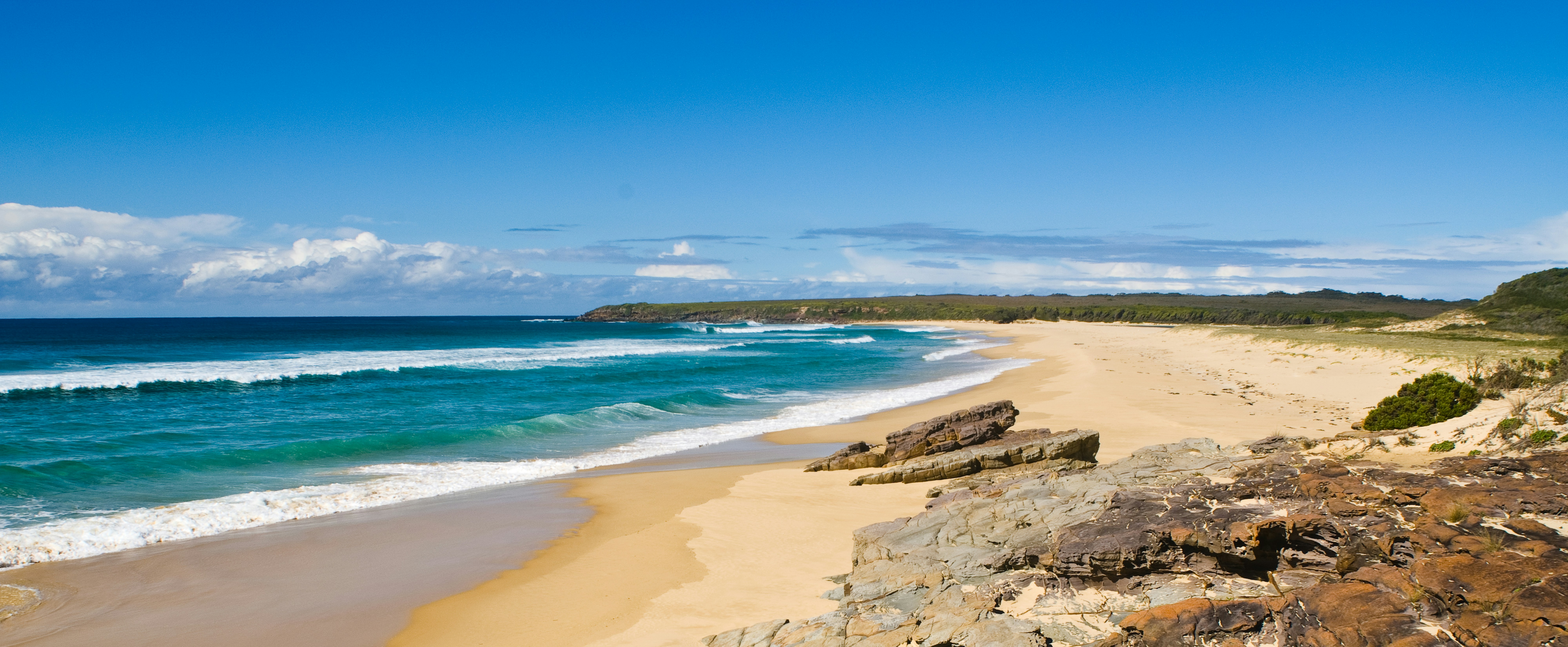 Sunlit Coastline: A Quiet, Expansive Beach Stretch