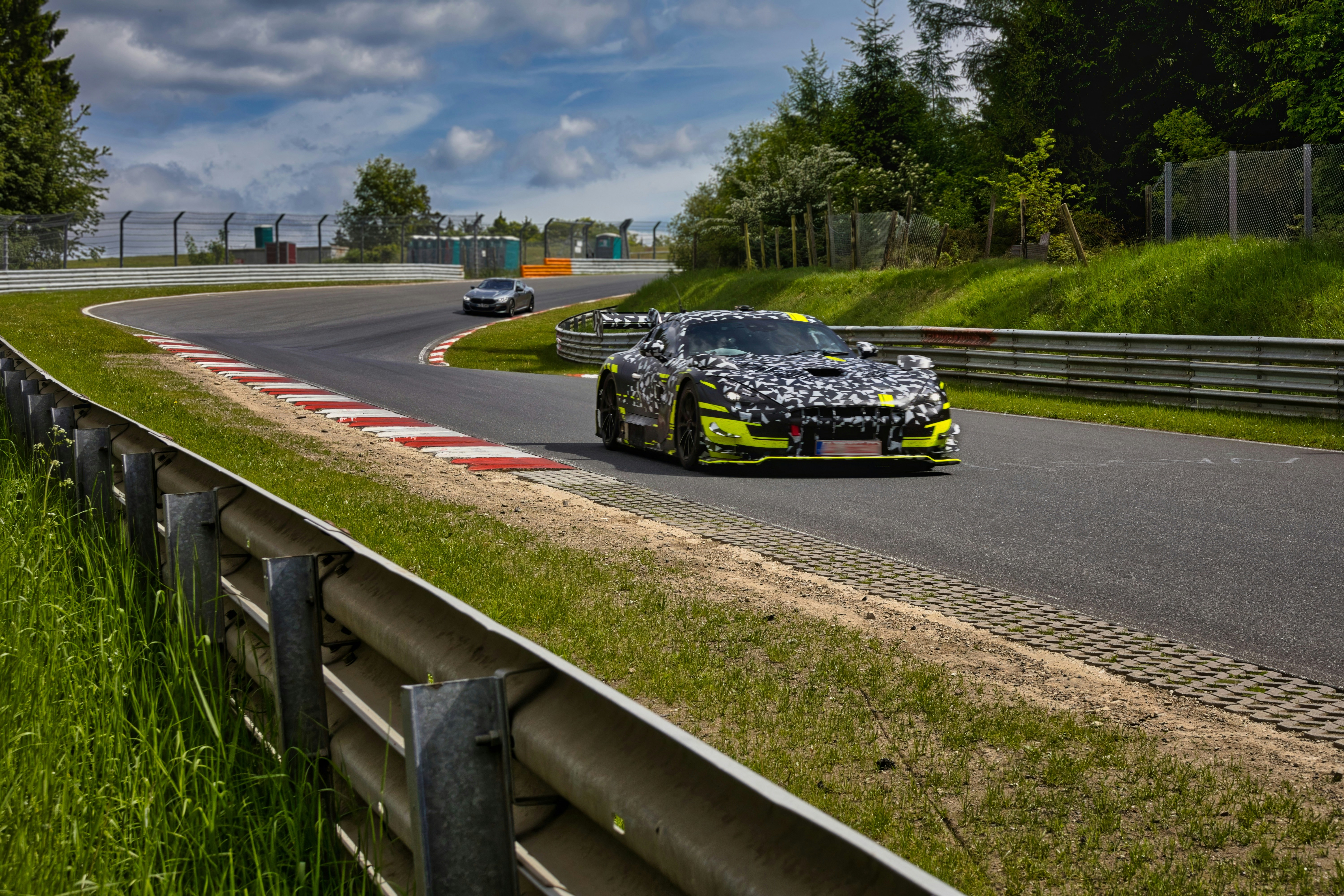 Neon-Tracked Racer Rounds the Crest