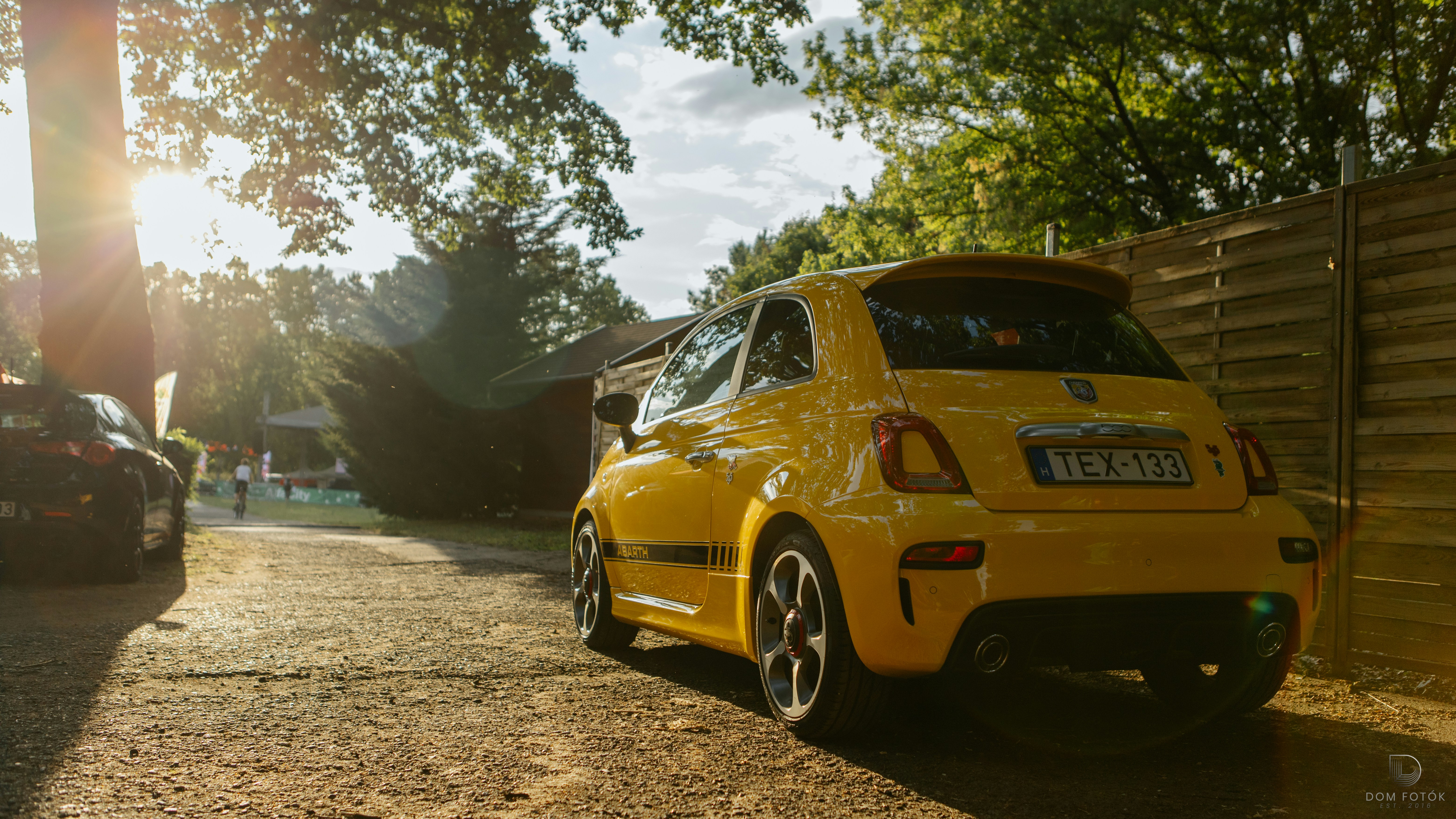 Yellow Hatchback in a Sunlit Parking Scene