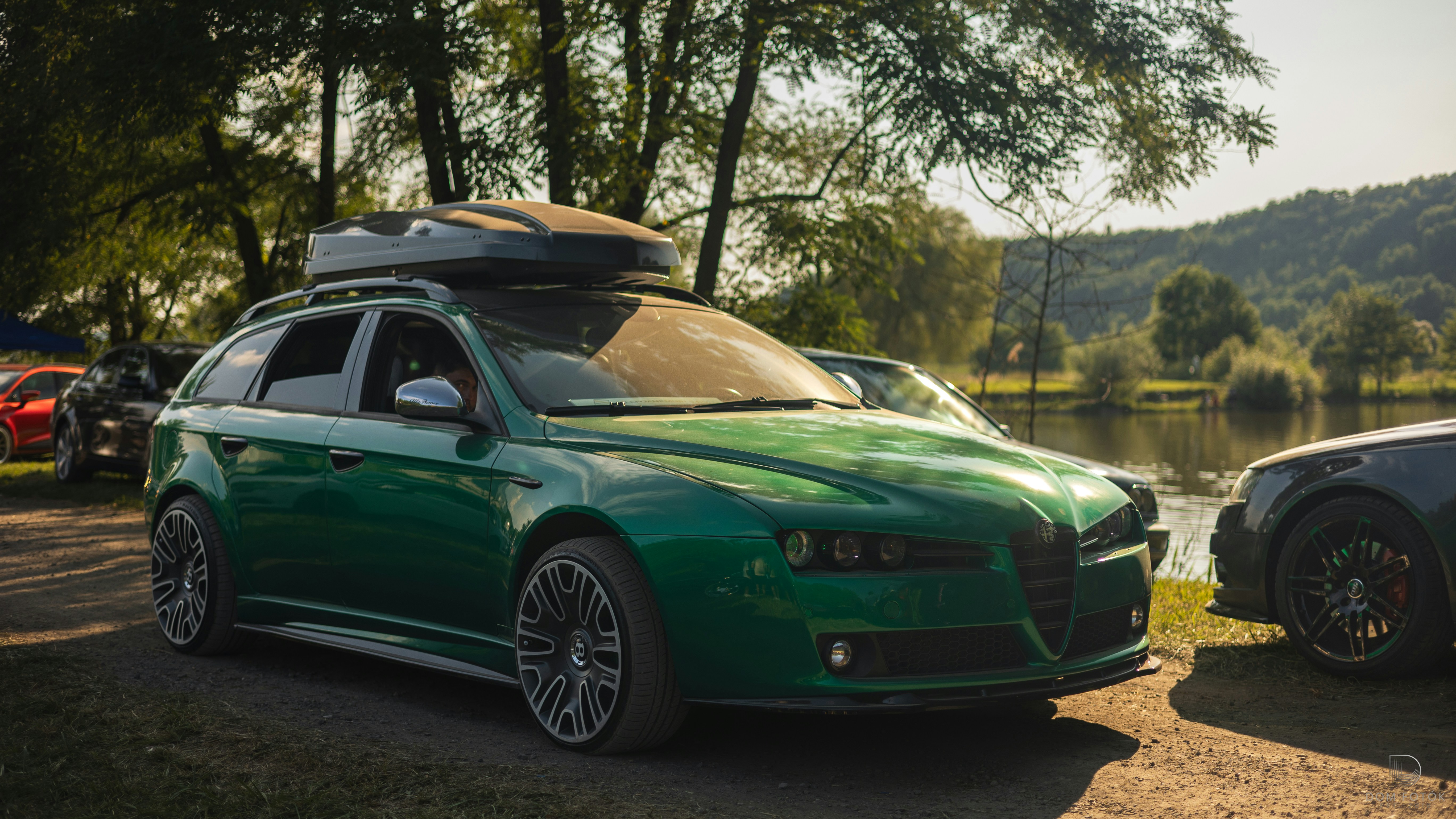 Emerald cruiser by the lakeside: a greenwagon under soft afternoon light