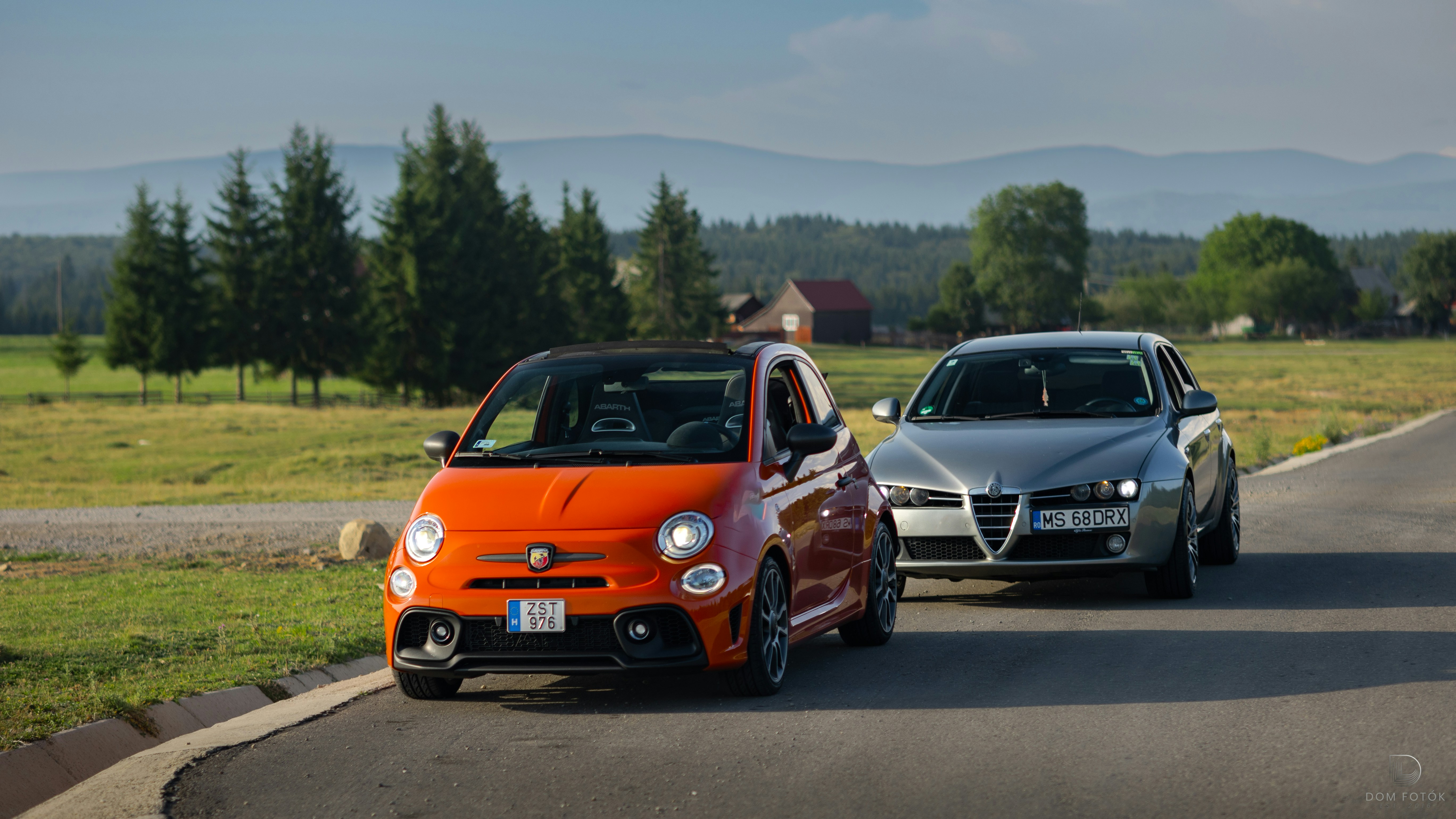 Orange Fiat 500 Abarth Leads the Pack on a Quiet Country Road