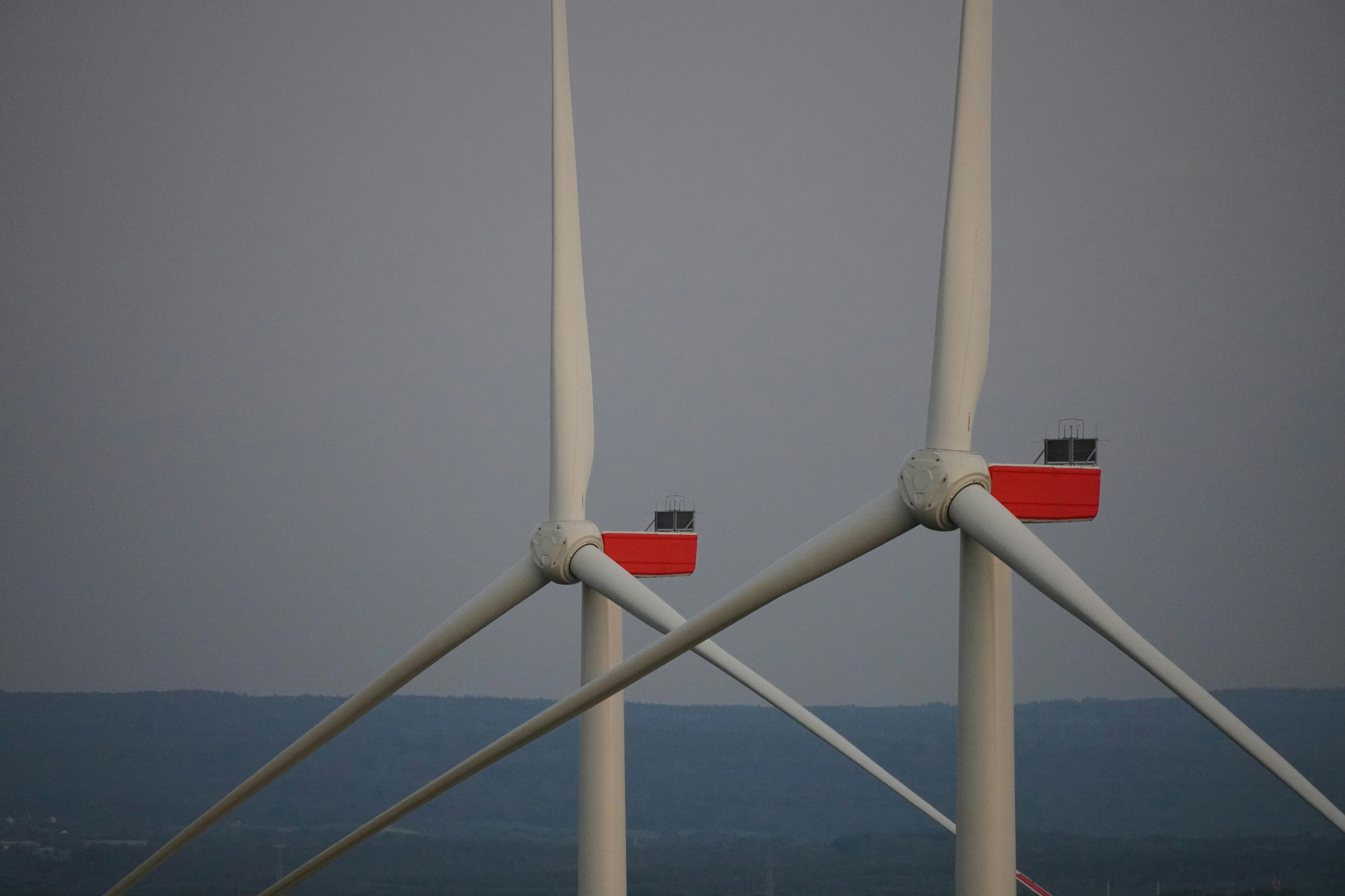 Red-topped wind turbines reach for the horizon