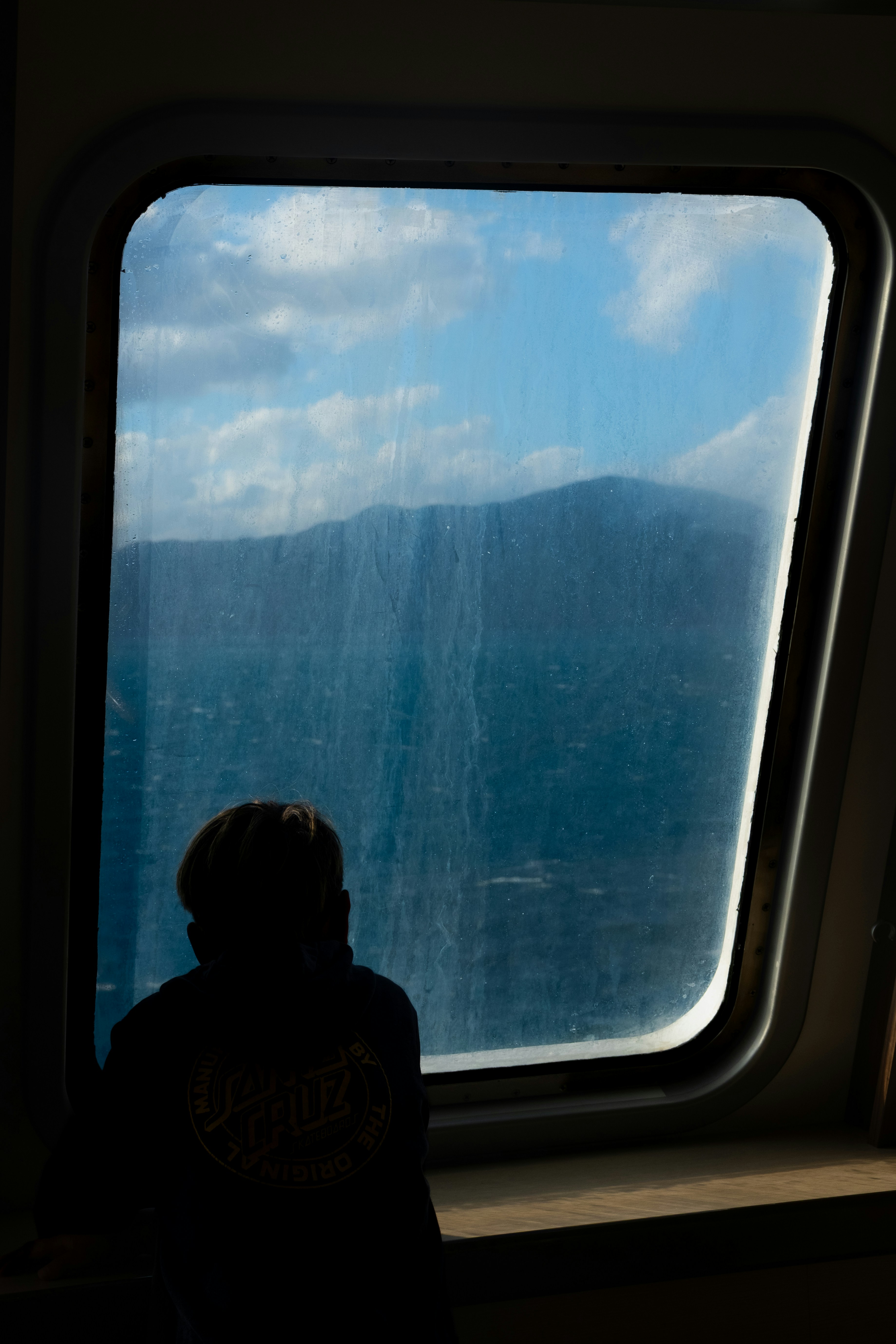 Silhouette at the Window: Watching the World Drift by
