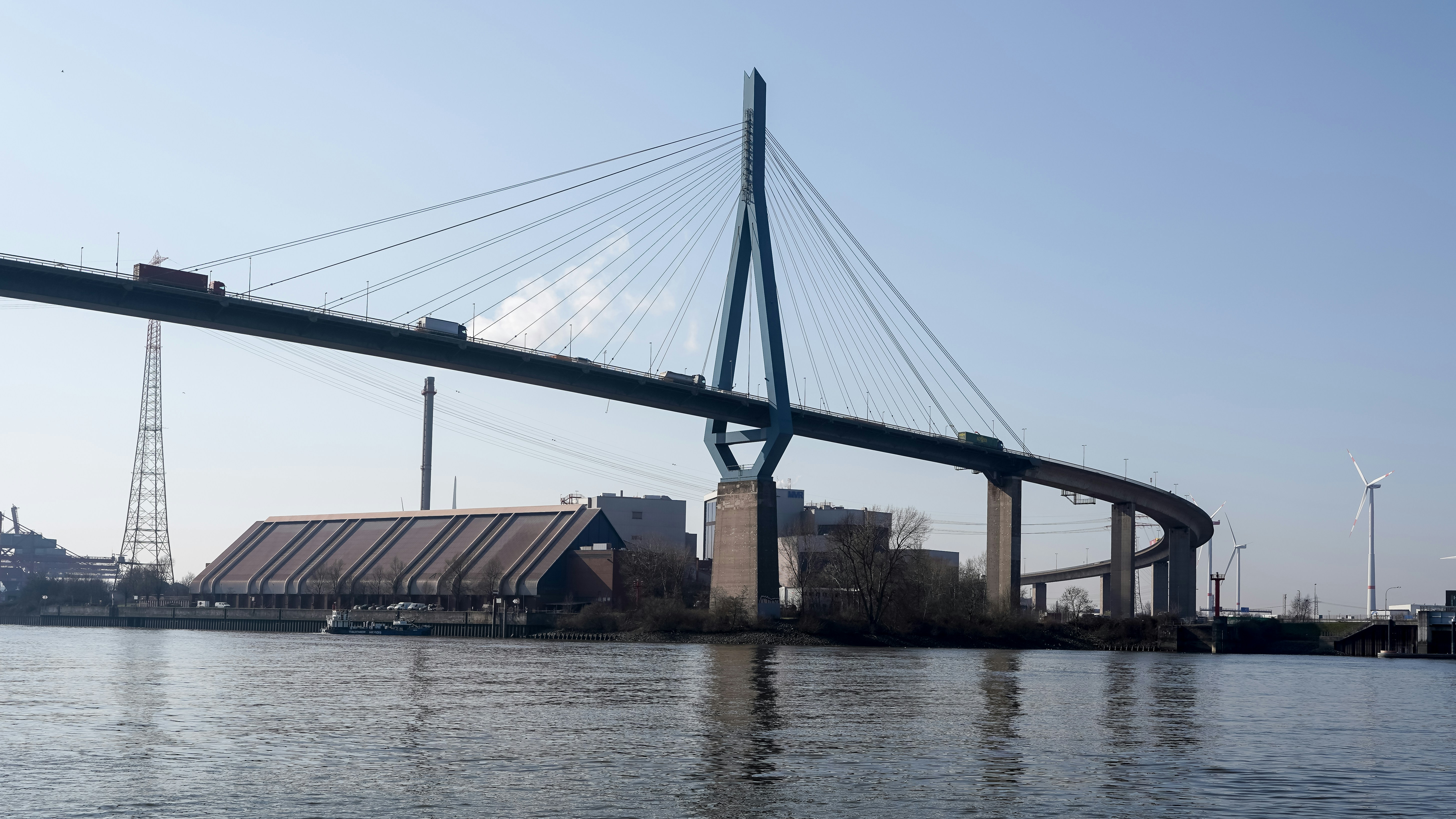 Cable-Driven Veins: A Riverbound Bridge Arcing Over Quiet Water