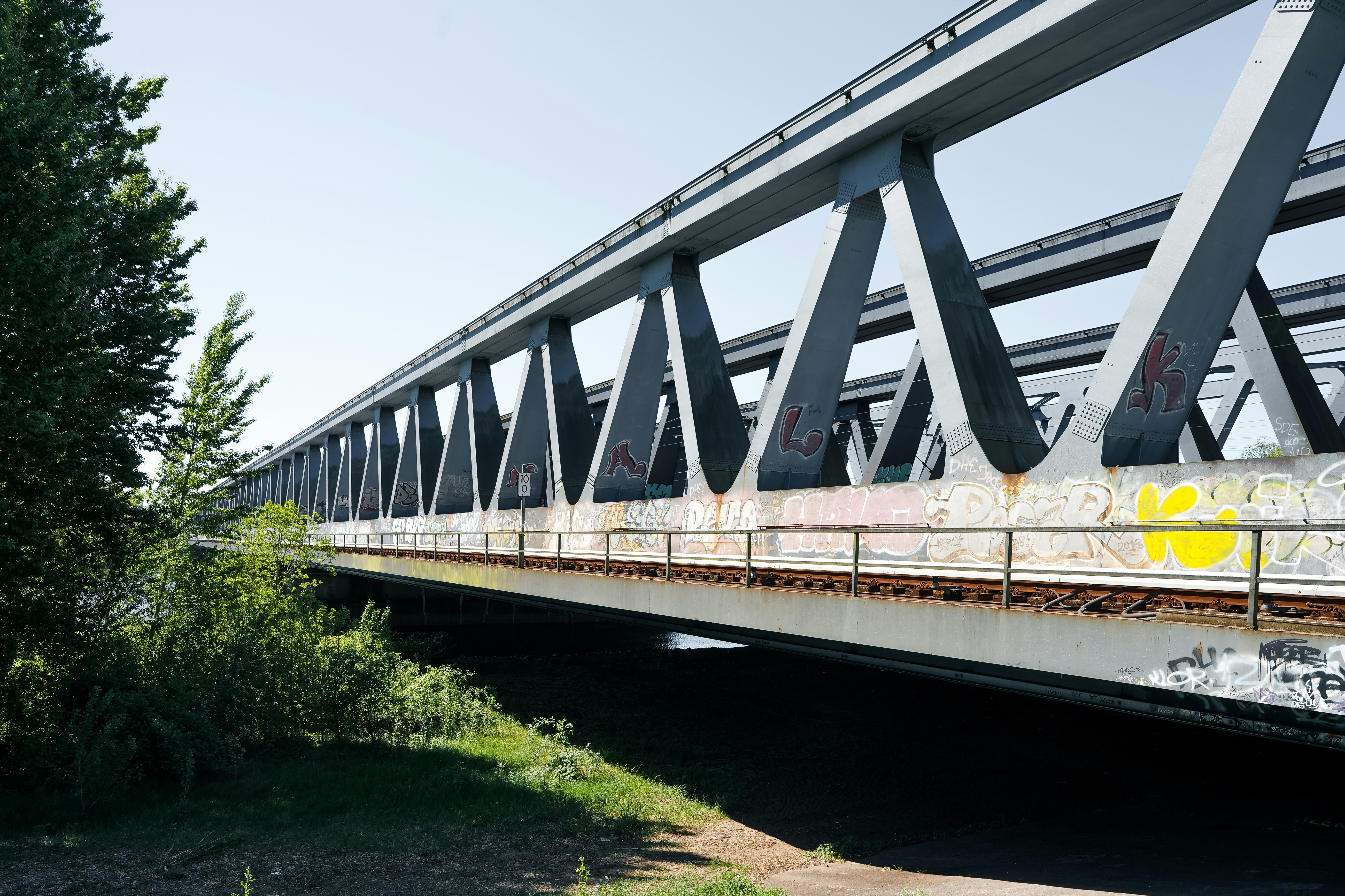 Graffitied Truss: A Quiet Long-Shot Under the Bridge