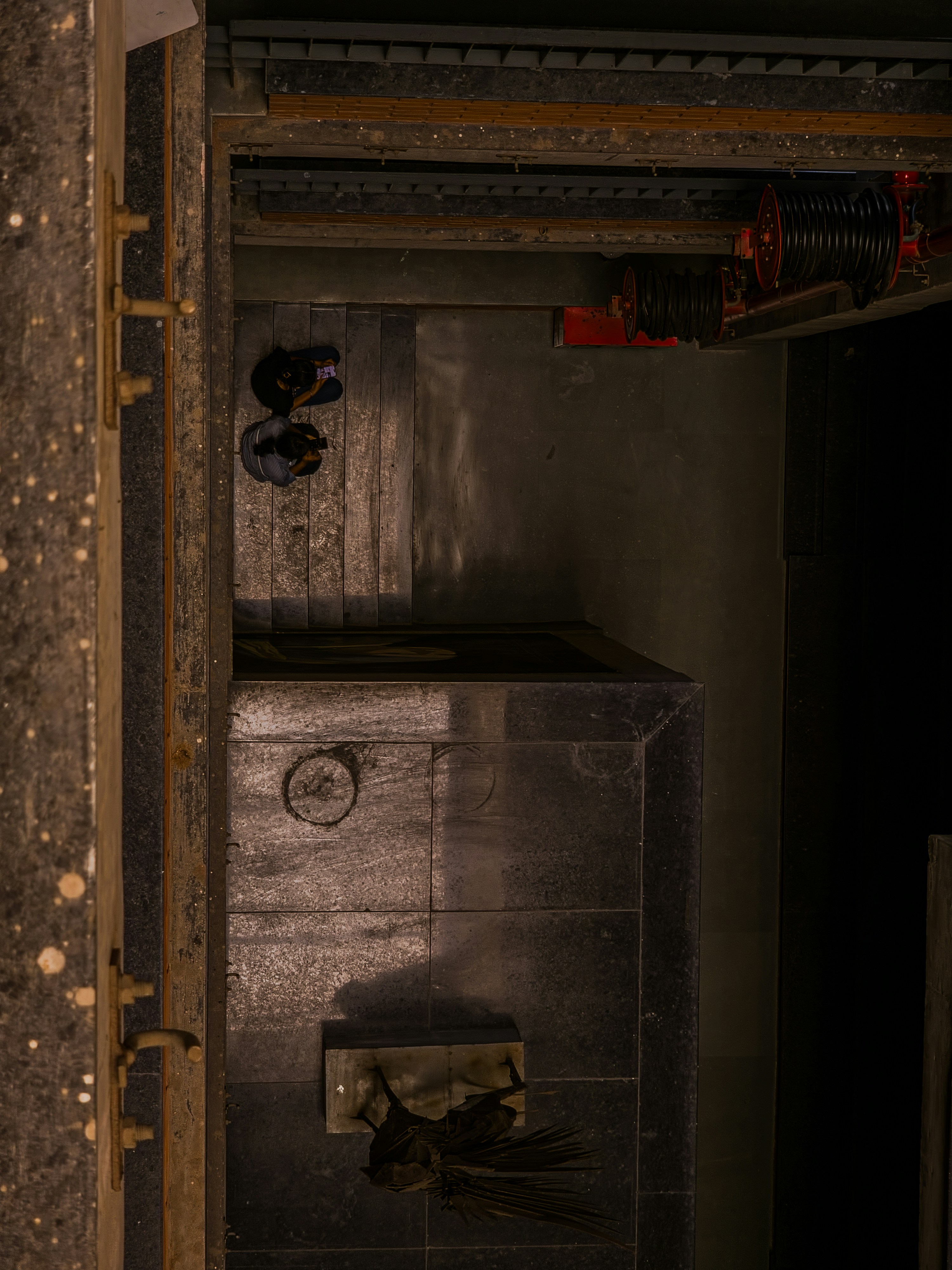 Industrial Stairwell Echoes: Two Figures on a Dark Landing