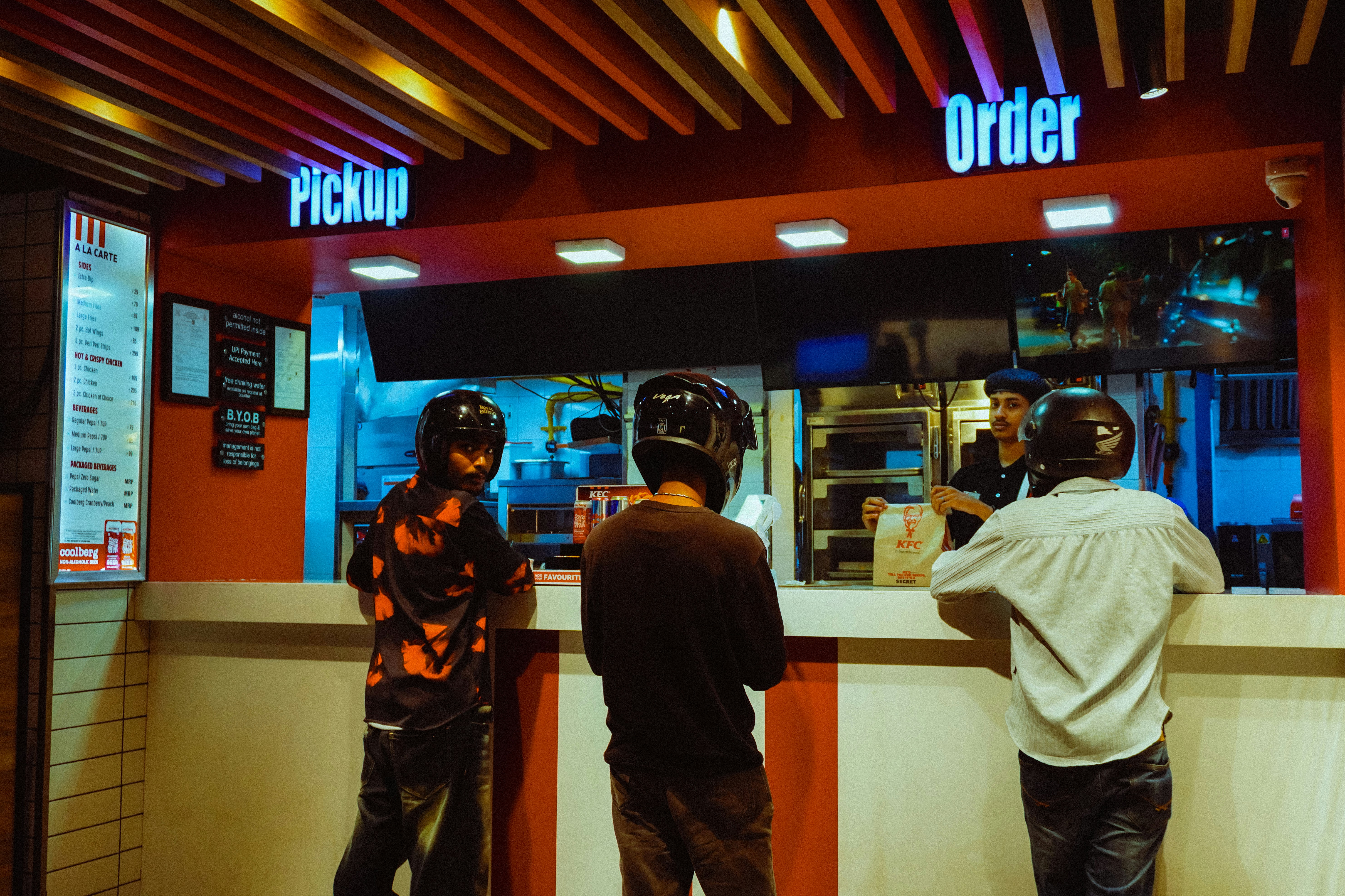 Midnight Service Window: Neon Lights and Quiet Interaction at a Fast-Cood Counter