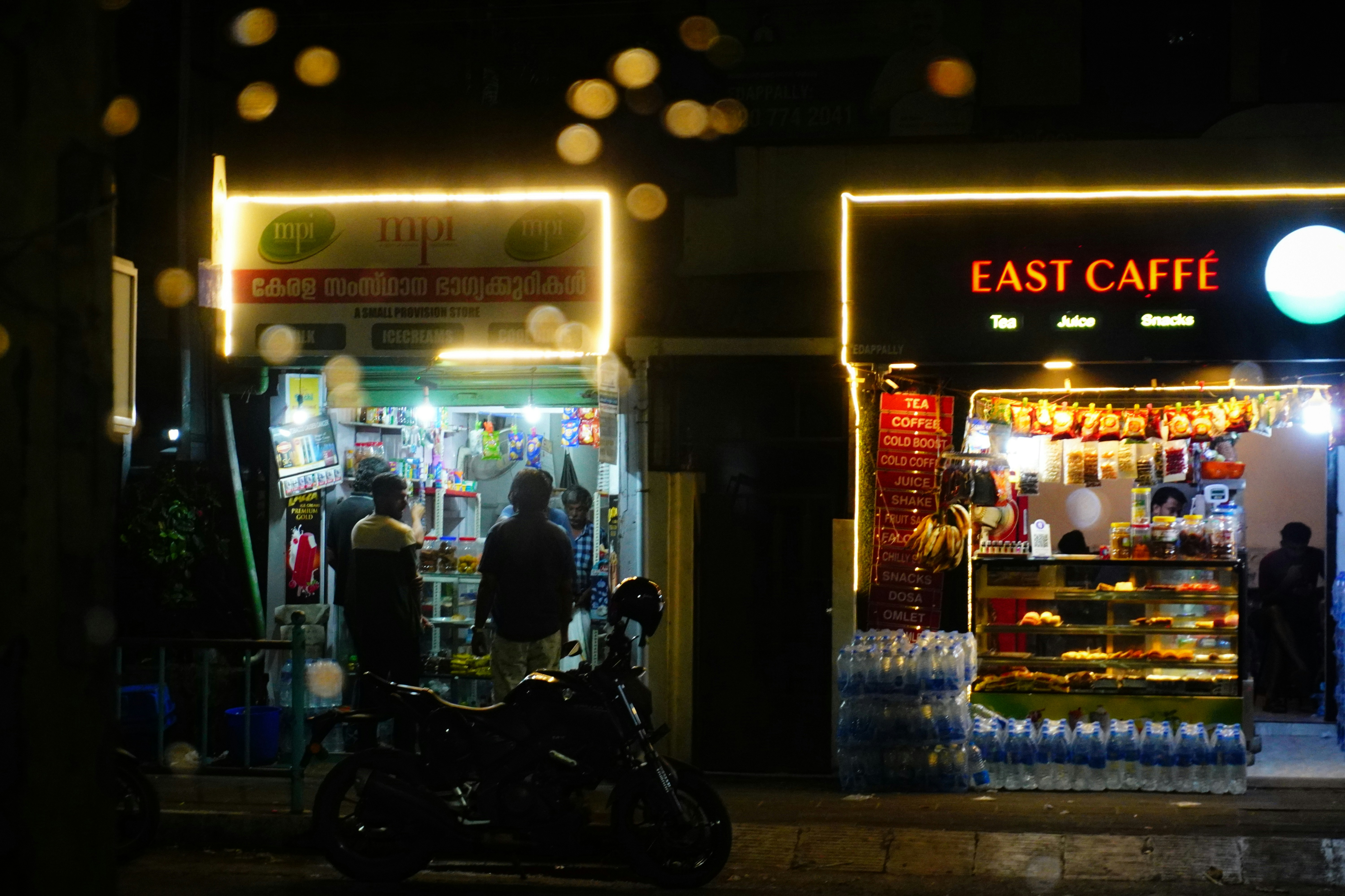 Neon twilight at a bustling night market café row