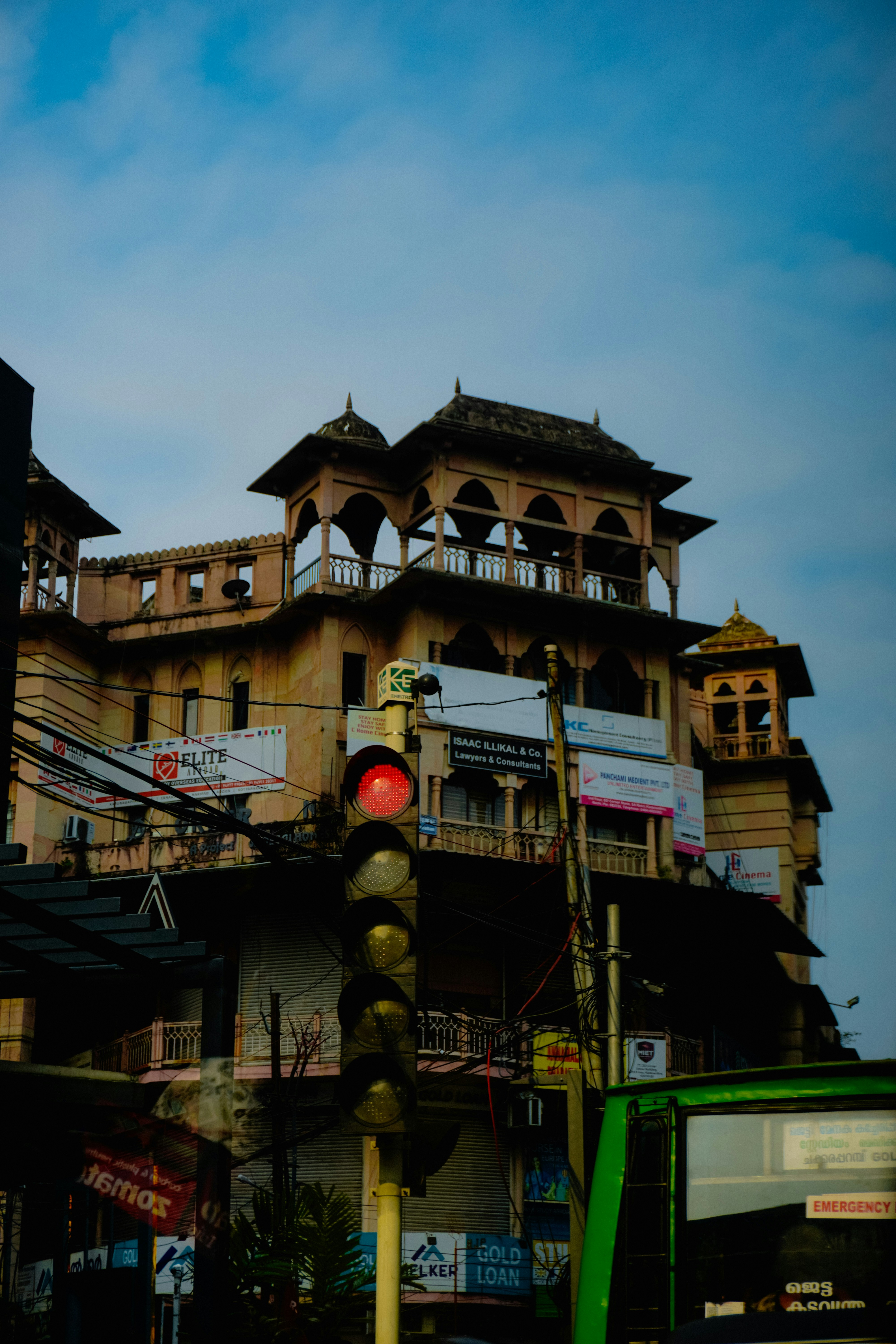 Rising Rooftop: A Layered Indian Street Facade under a Blue Sky