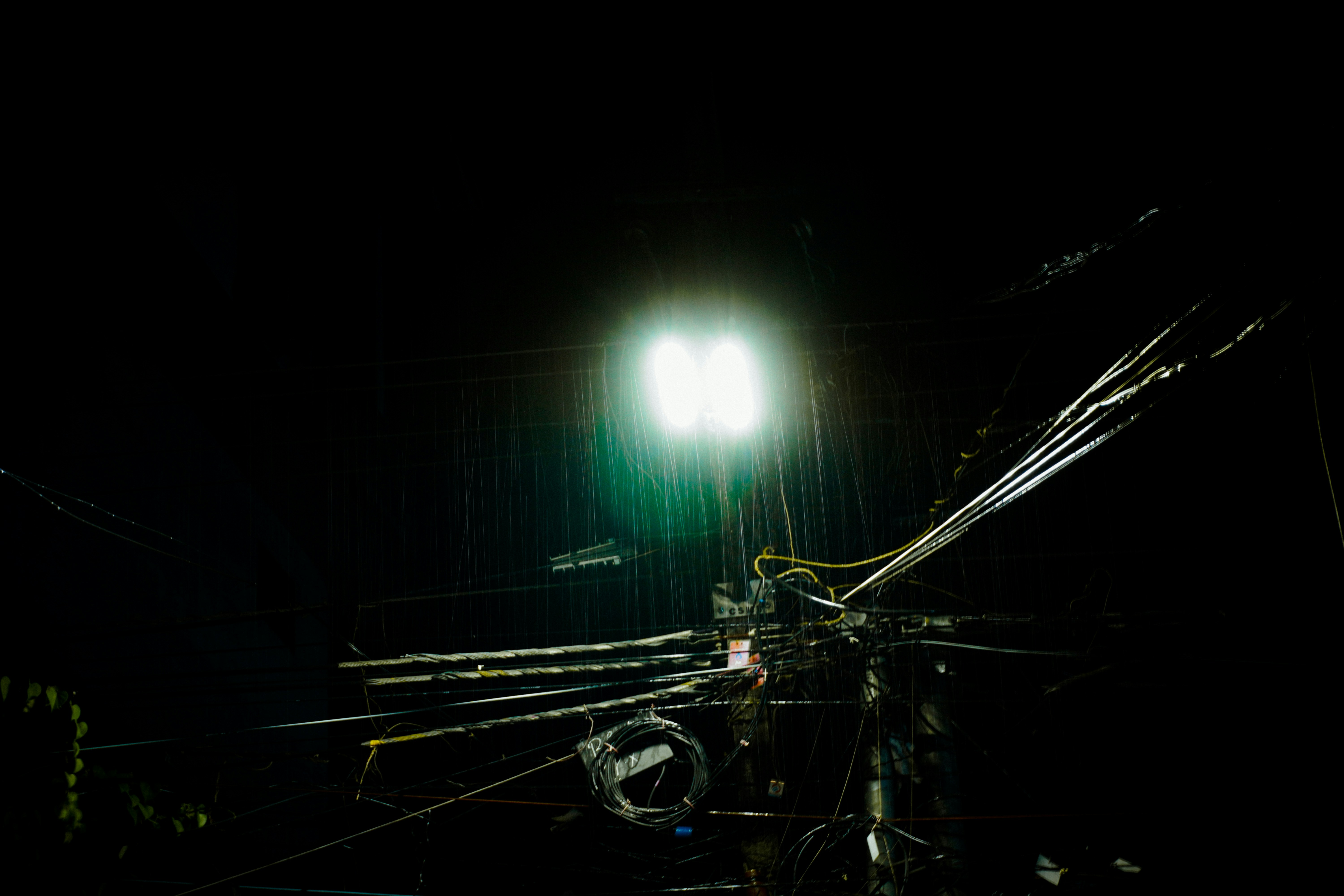 Bright stadium lights illuminate a dark night sky.